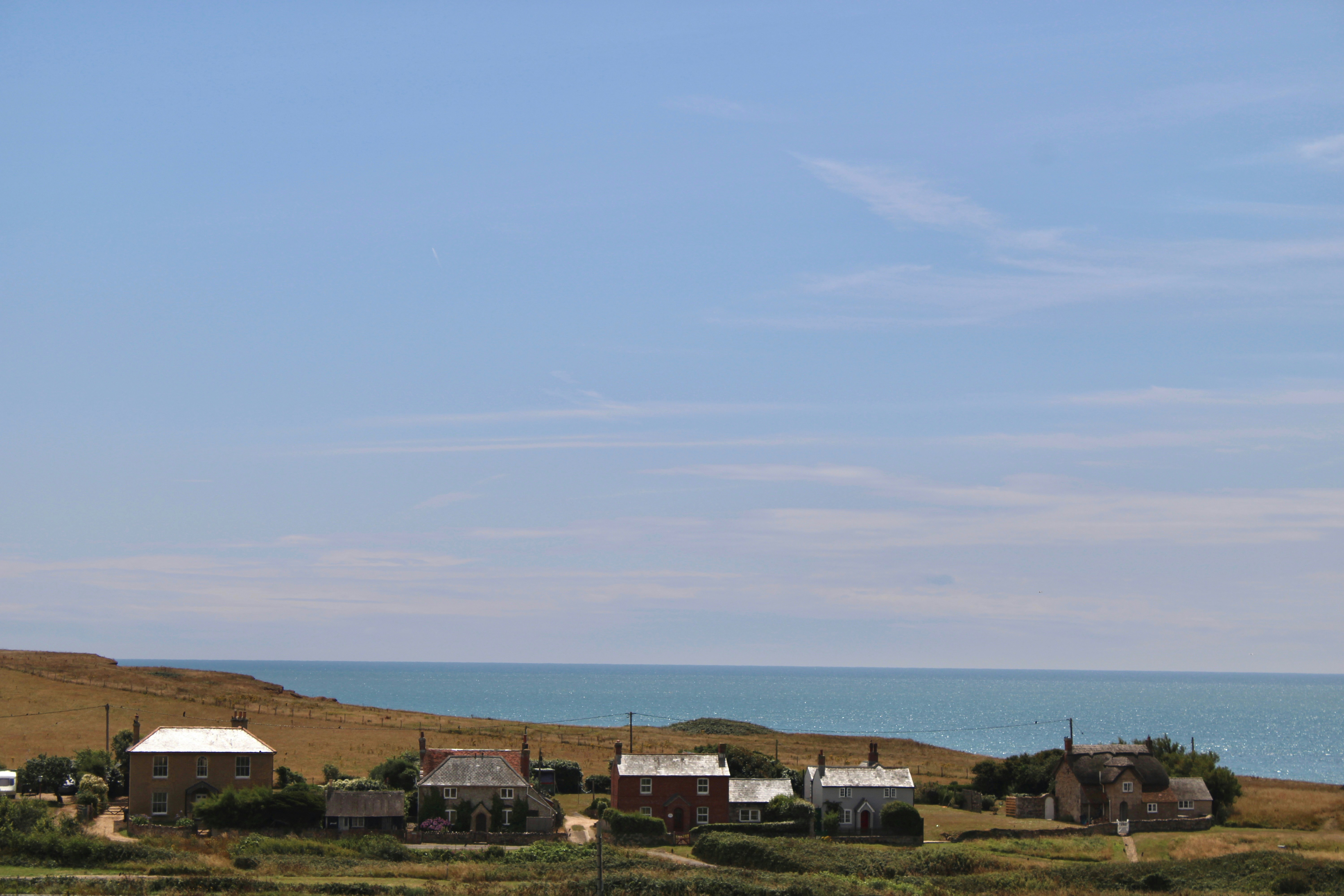 Seaside Serenity: Coastal Homesteads Under a Vast Sky