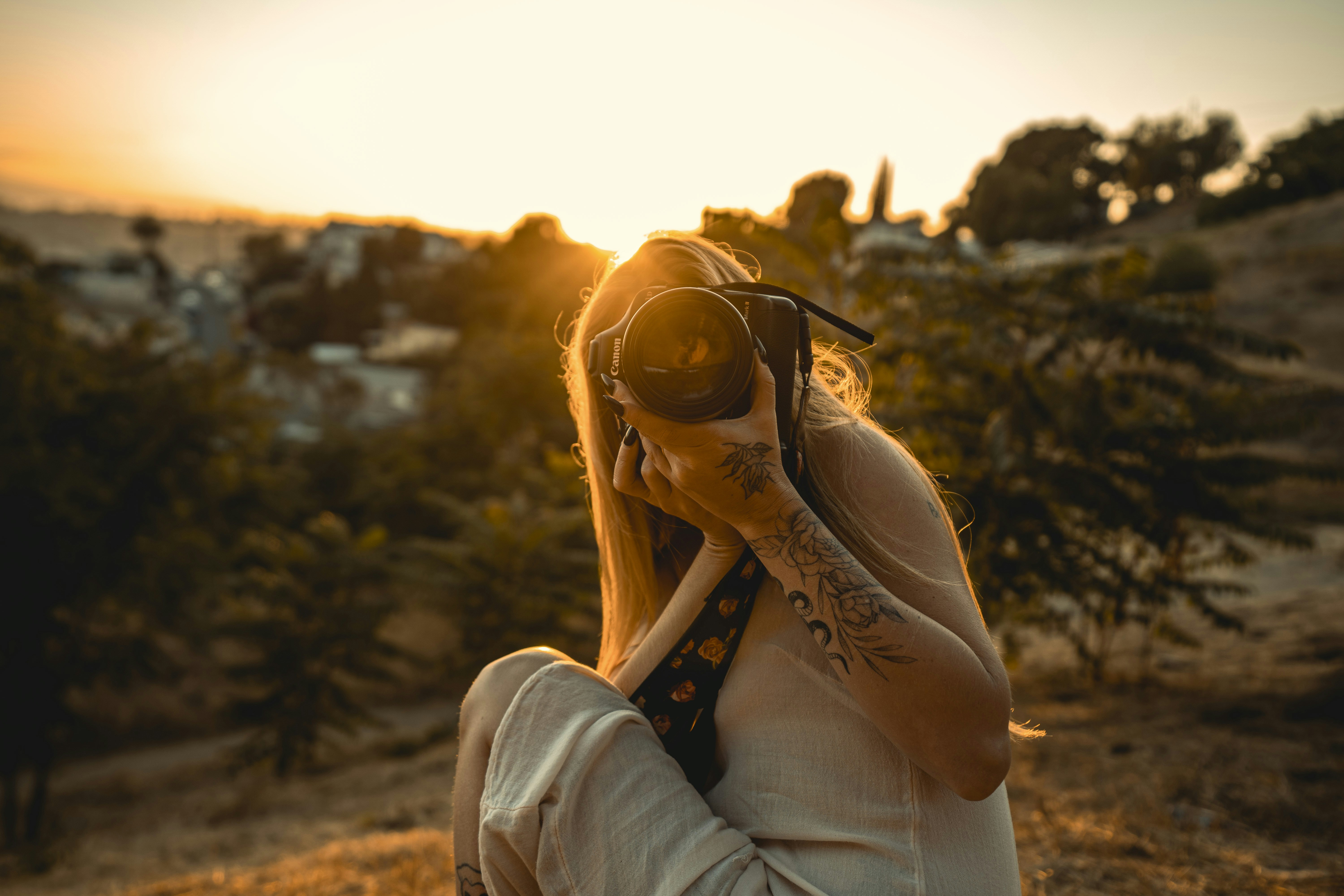 Self portrait taken in the hills of Los Angeles, California during golden hour | Woman with camera photographing sunset landscape