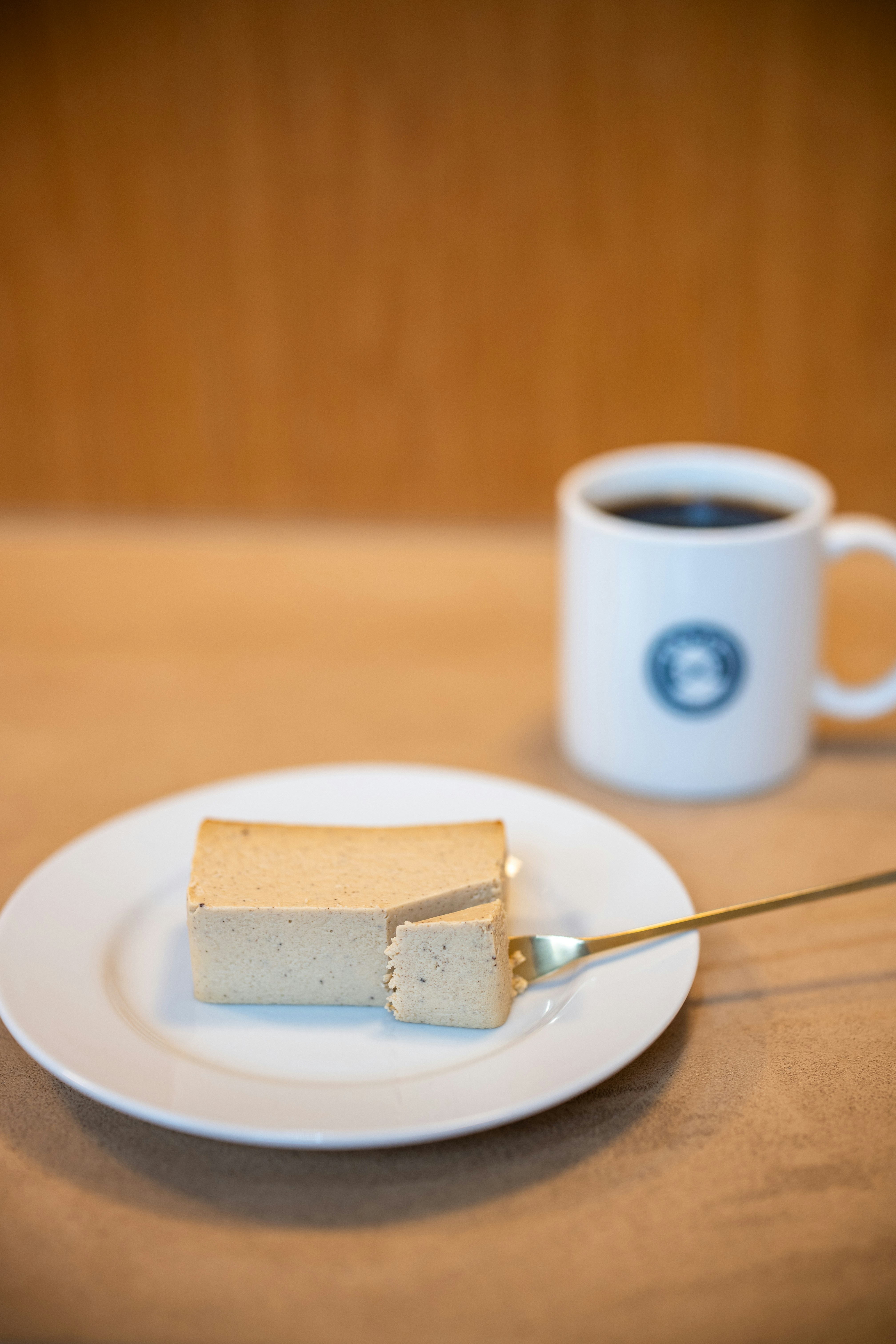 Slice of cheesecake with coffee on a table