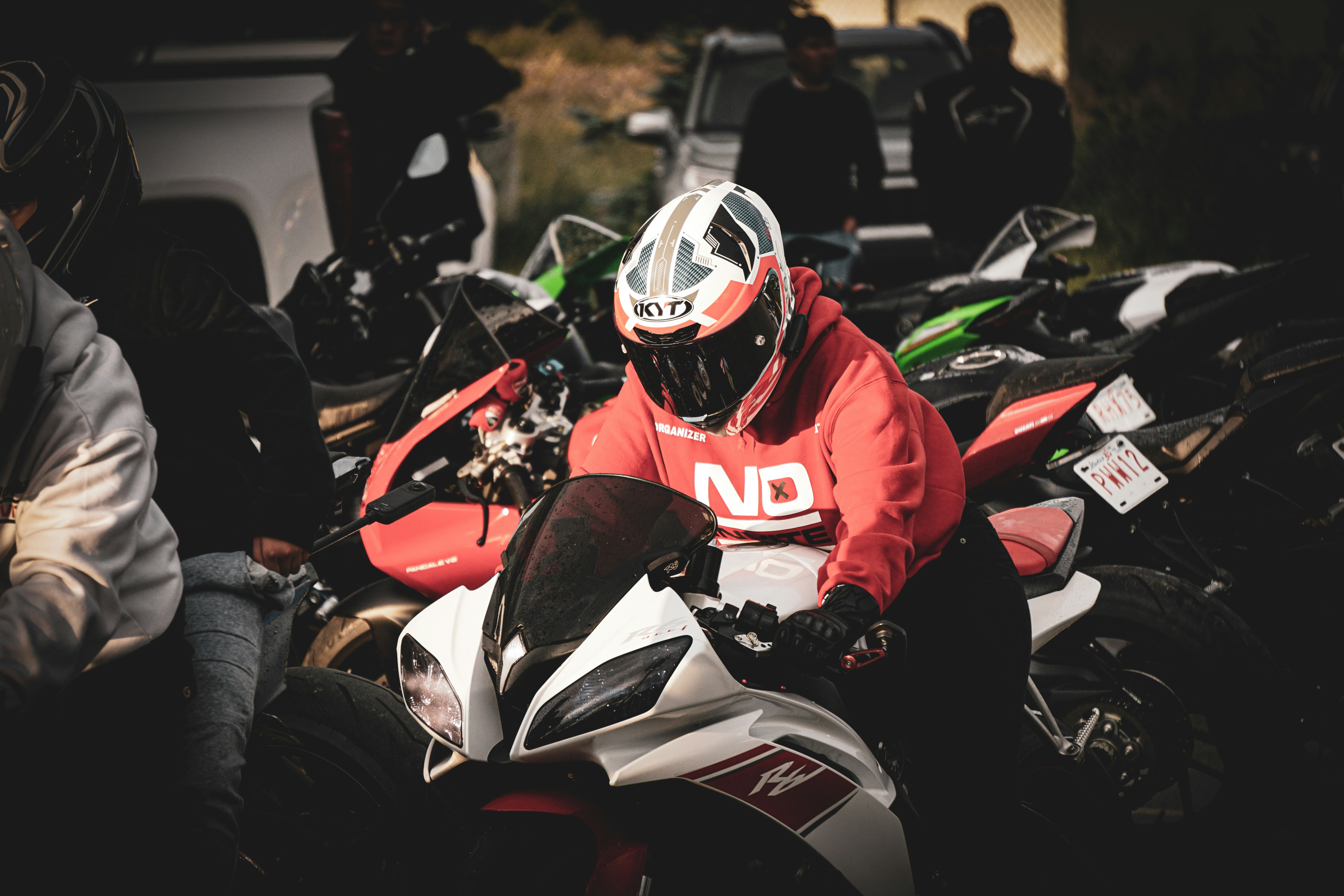 Motorcyclist wearing a red jacket and helmet