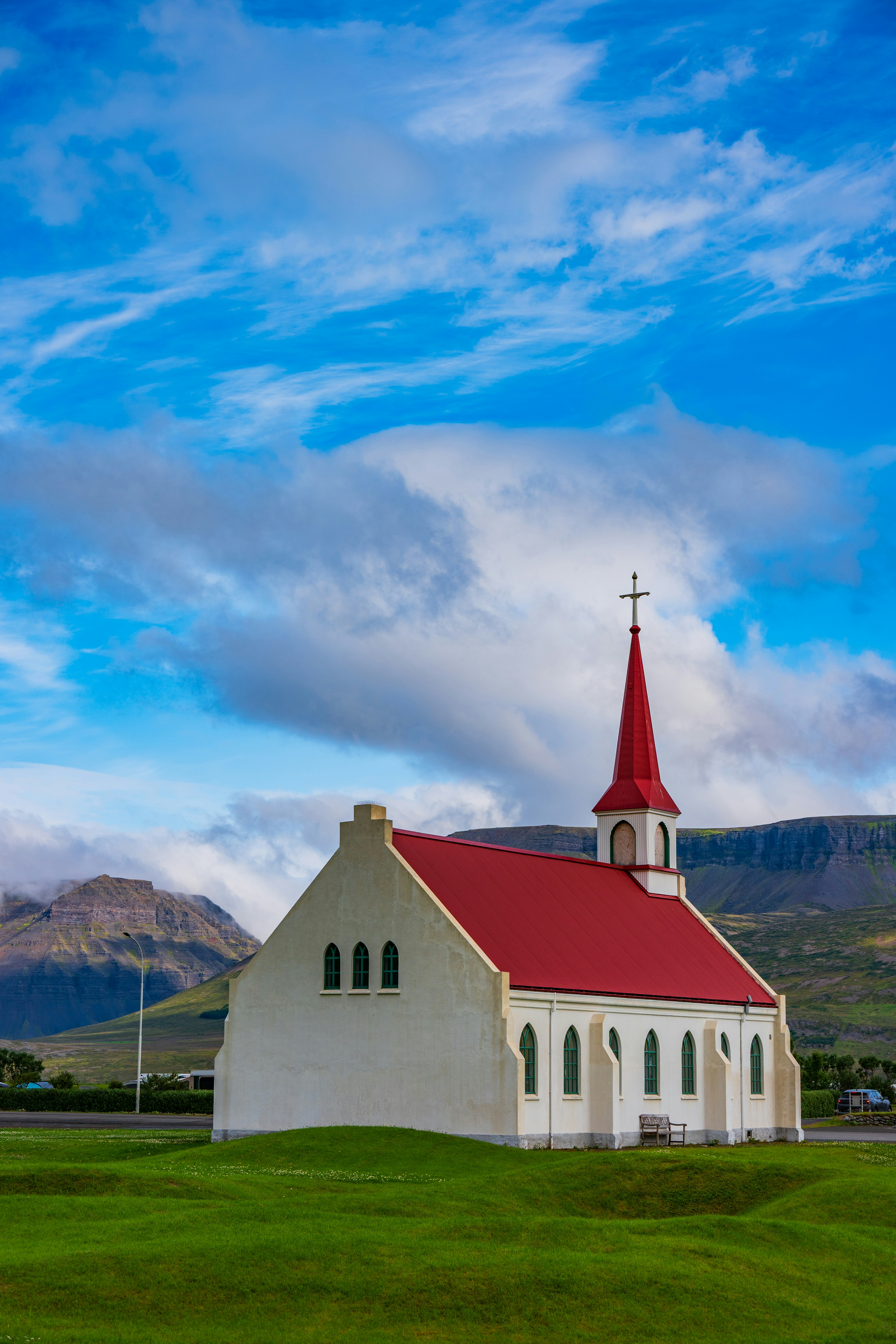 White church with red roof under blue sky