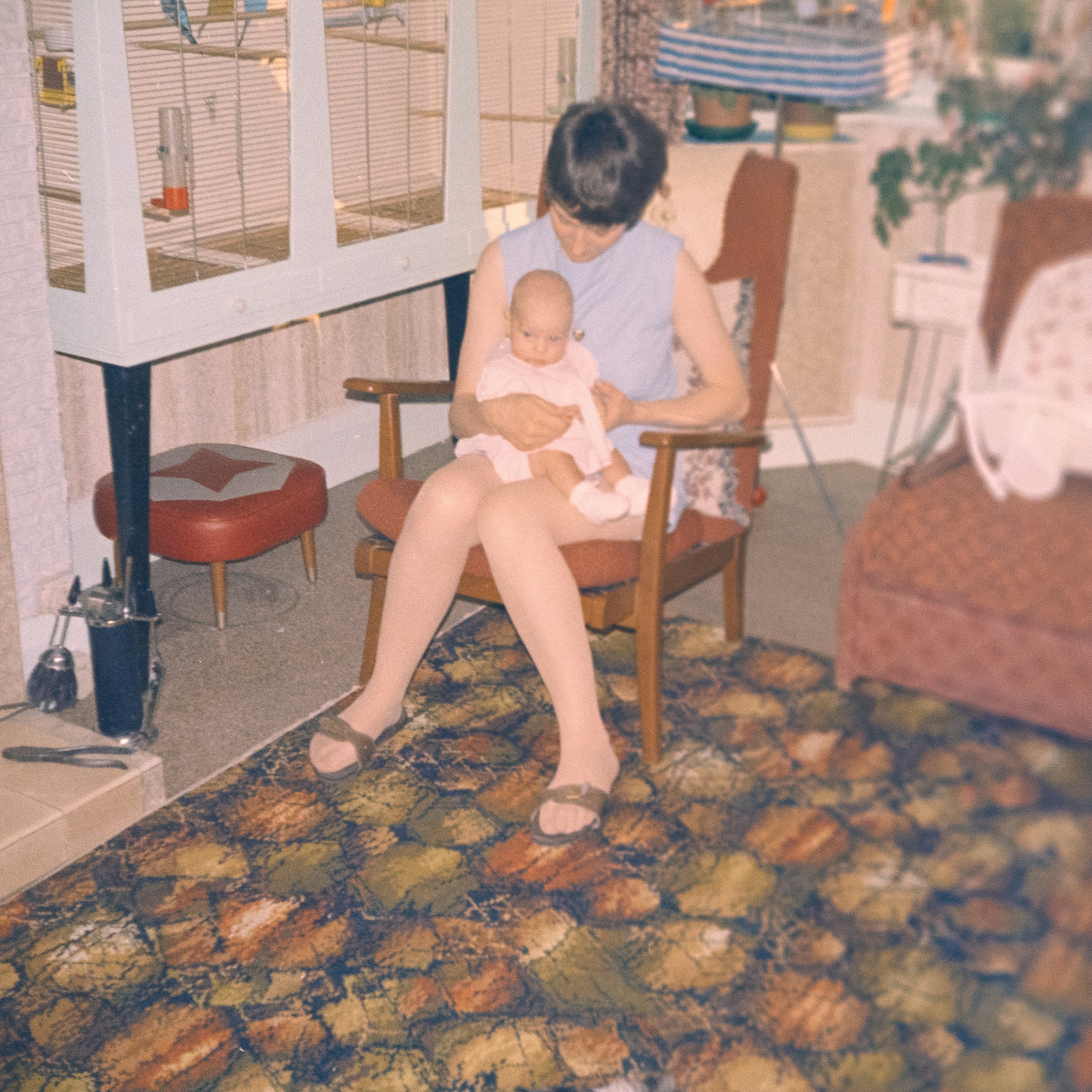 Woman holding a baby in a chair