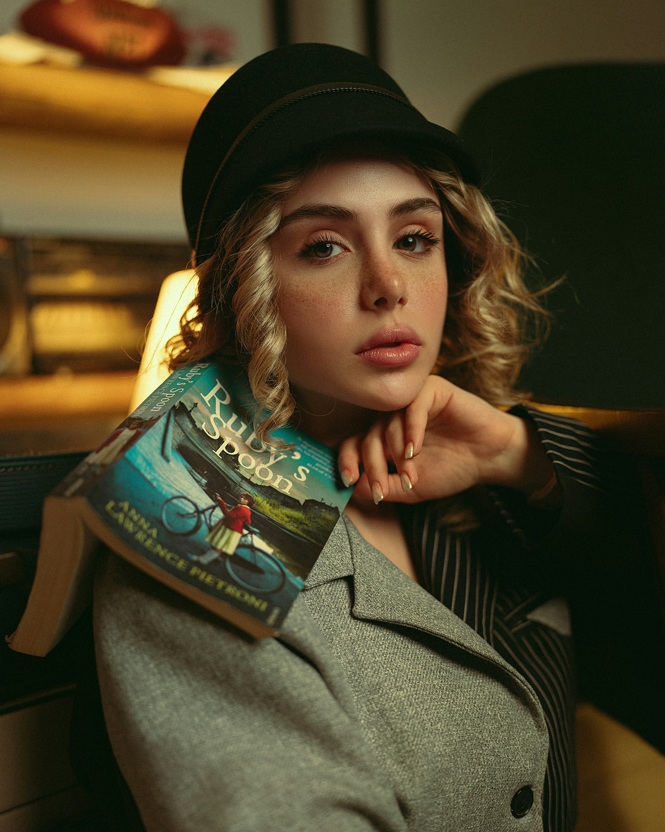 Young woman with book resting on shoulder