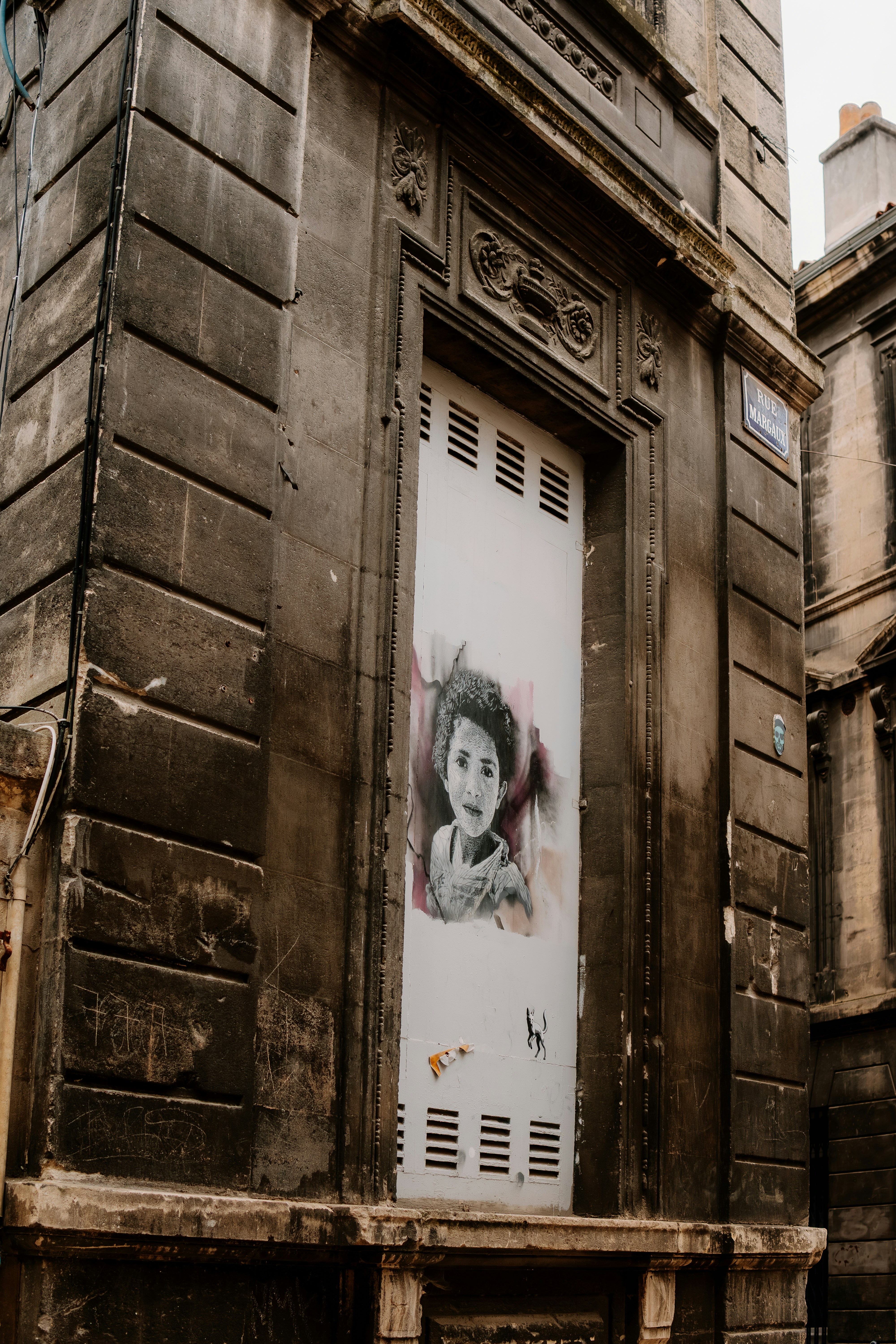 A Quiet Child Emerges from the Stone Archway