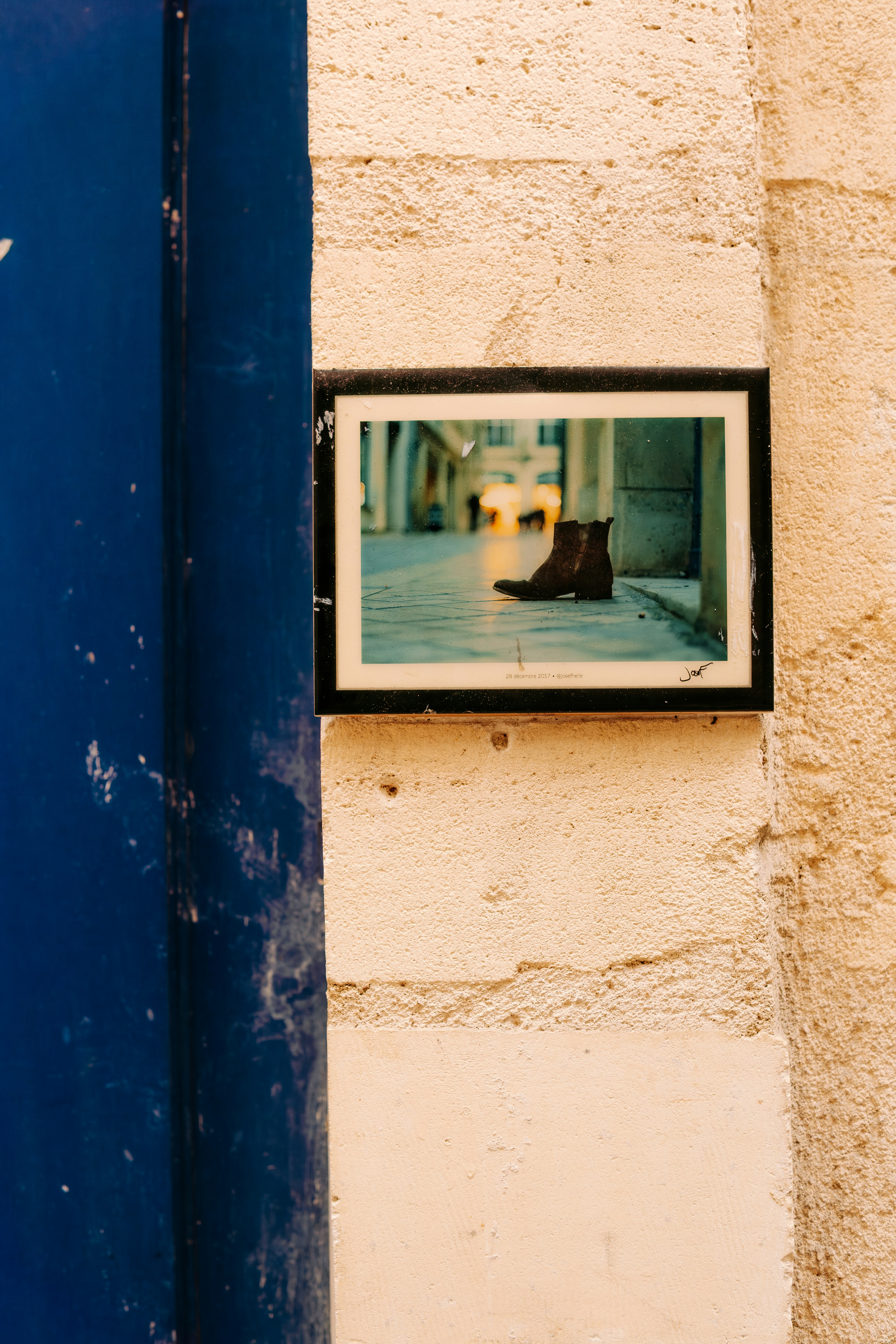 Street art | Framed artwork of a single boot indoors