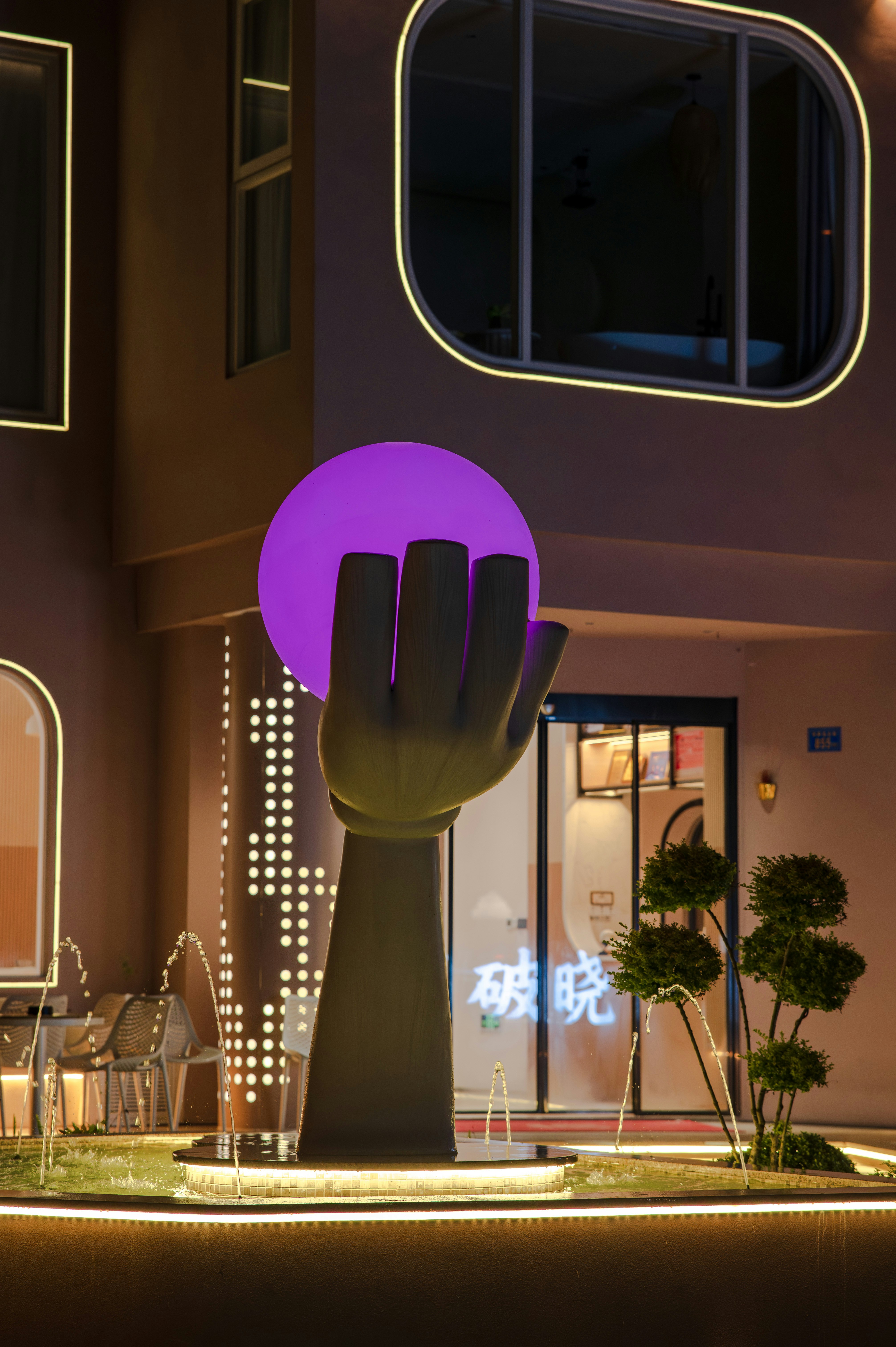 Glowing Sphere and Hand Sculpture Framed by Neon Architecture