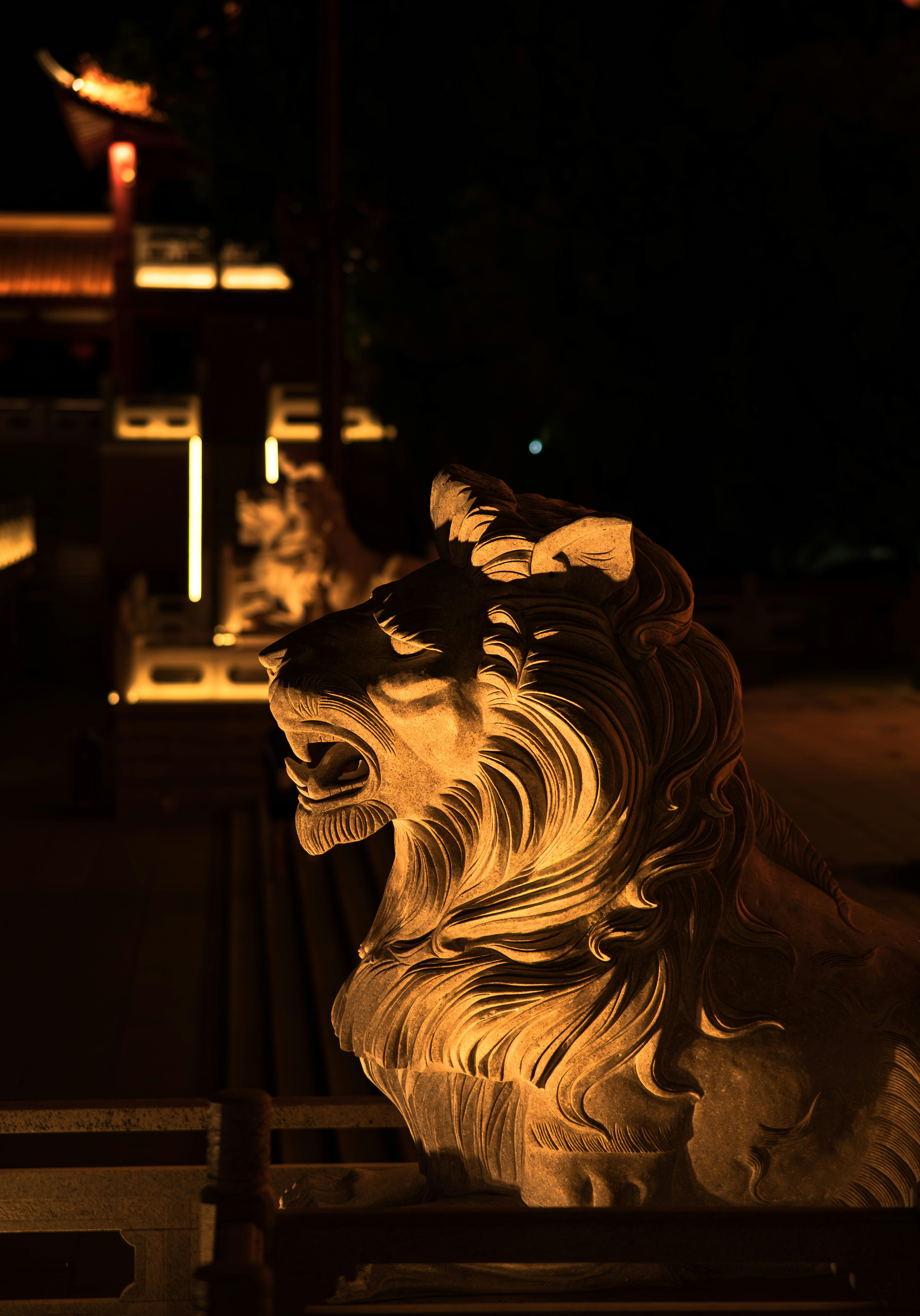 Night-Glow Guardian: A Stone Lion Illuminated on Temple Steps