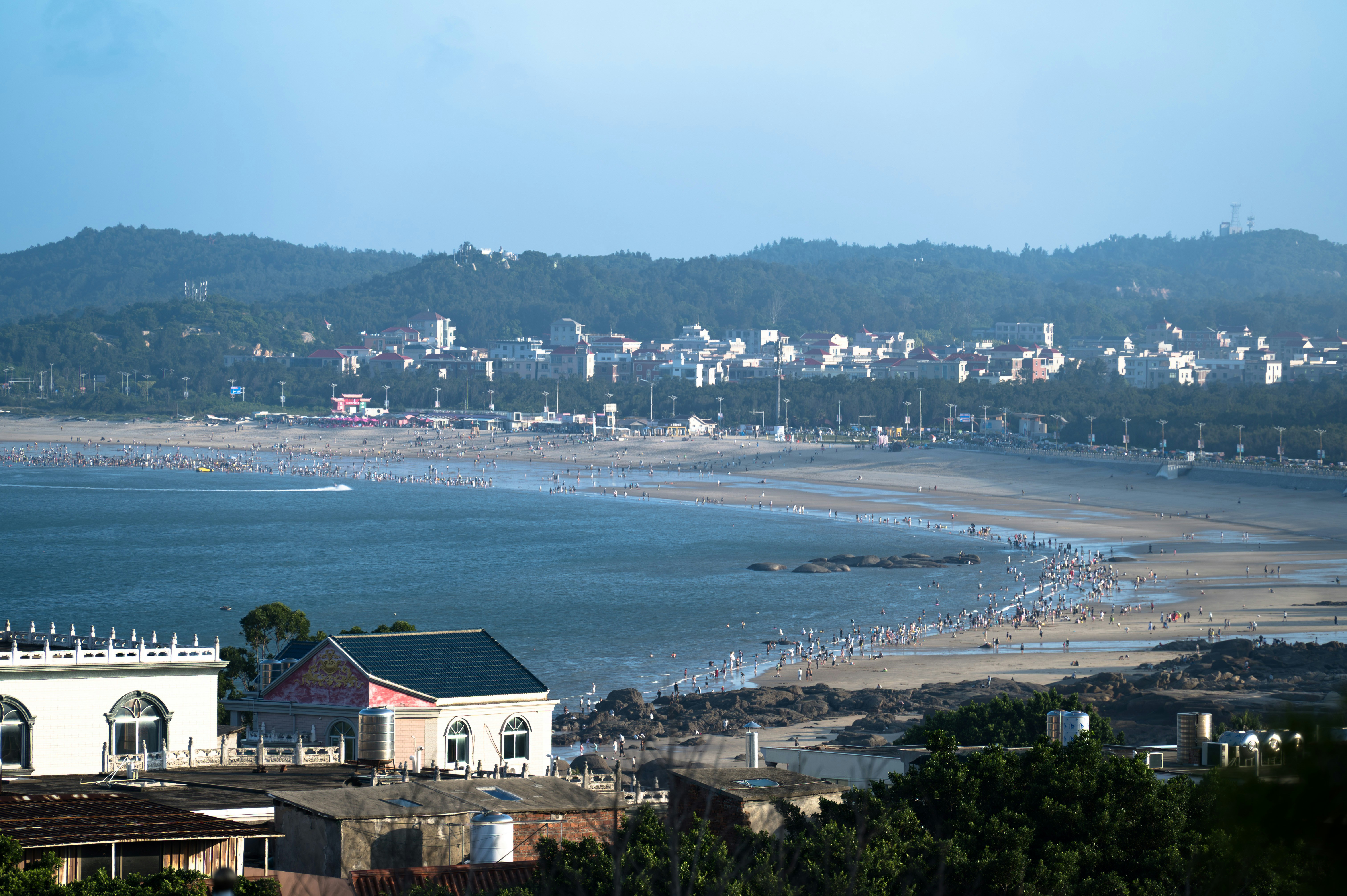 Coastal town with a bay and distant hills