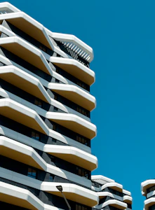 Layered White Balconies Piercing a Cerulean Sky