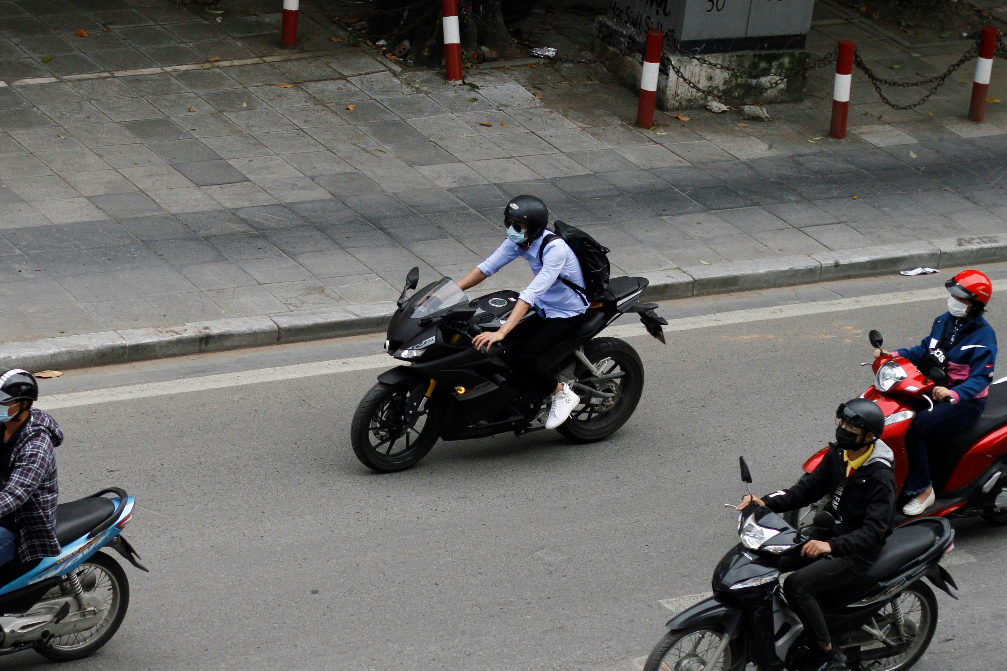Motorbikes in Hanoi, Vietnam | Motorcyclists riding on a busy street