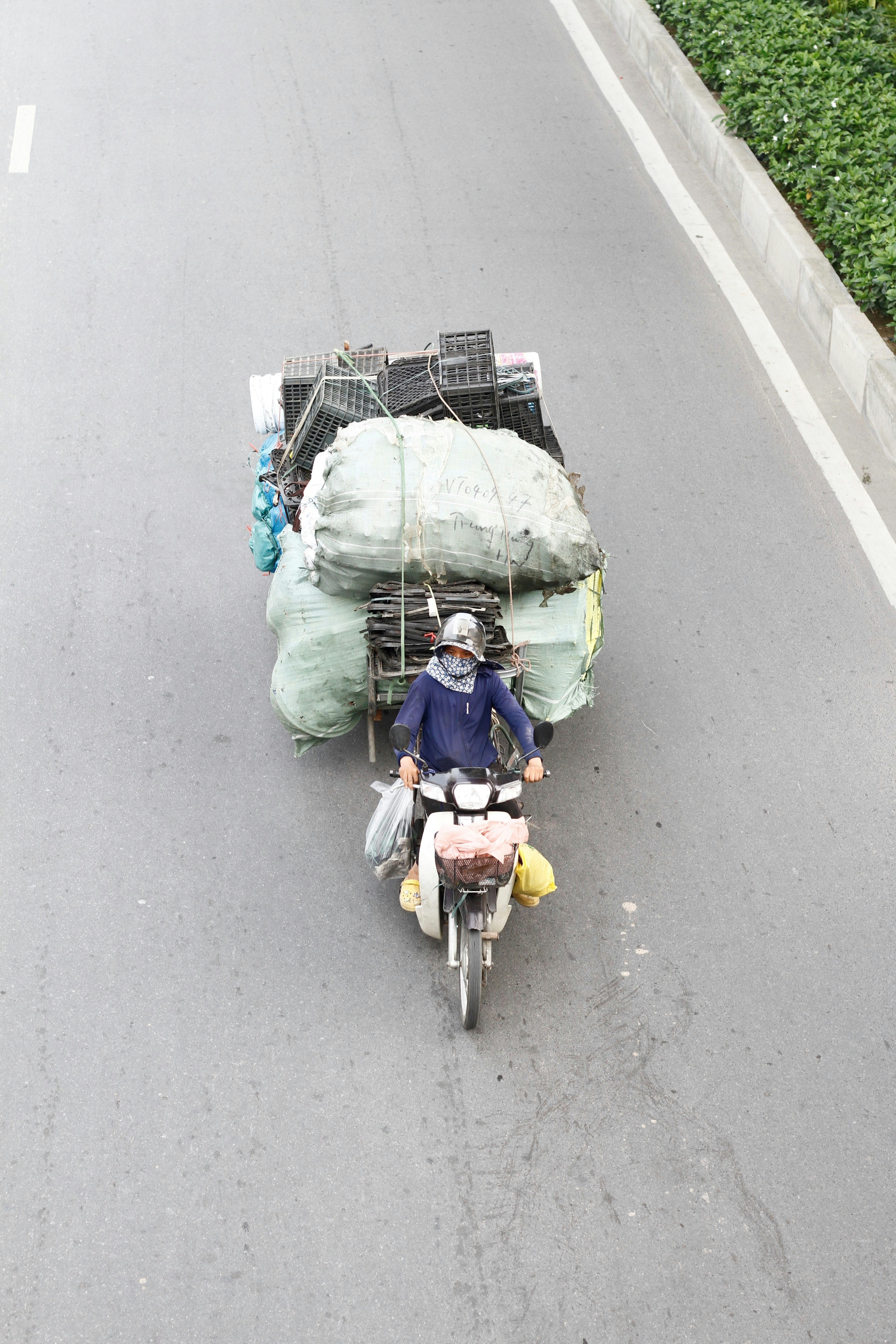 Motorbike in Hanoi, Vietnam | Motorcycle overloaded with goods on a road