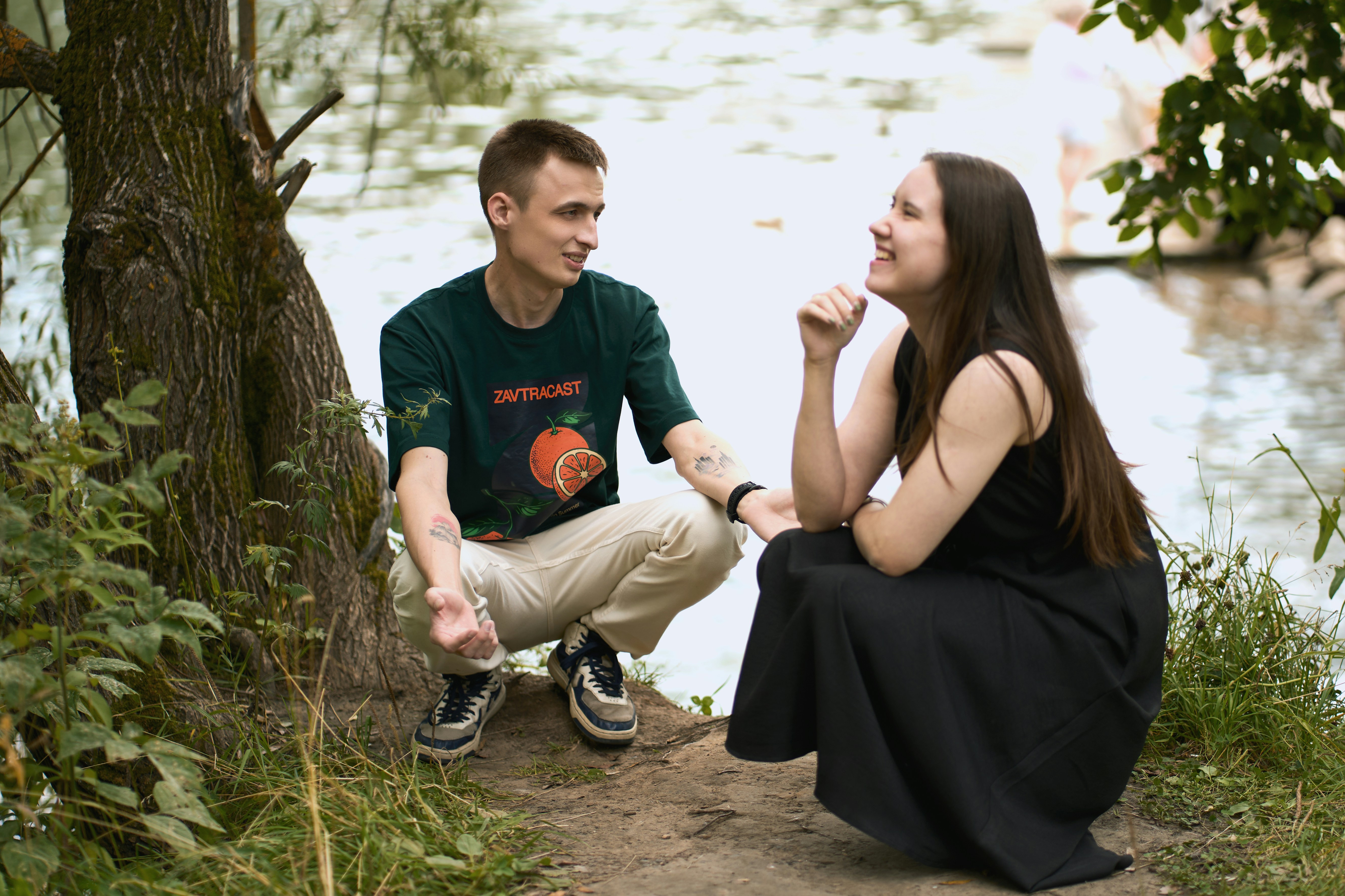 Faces are used with permission | Couple talking by a lake in the woods