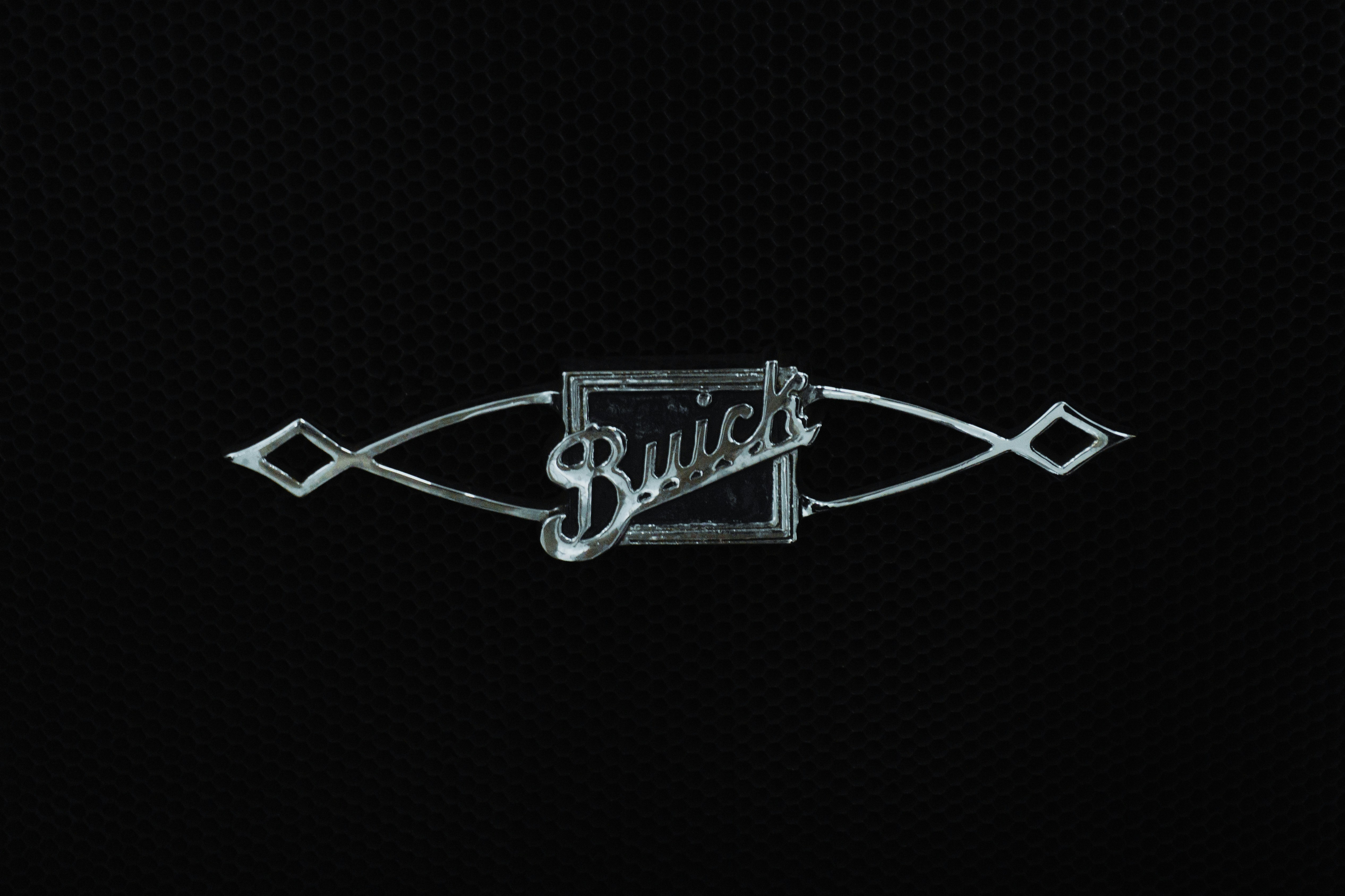 Classic Buick logo displayed against a textured black background, emphasizing its vintage automotive heritage.