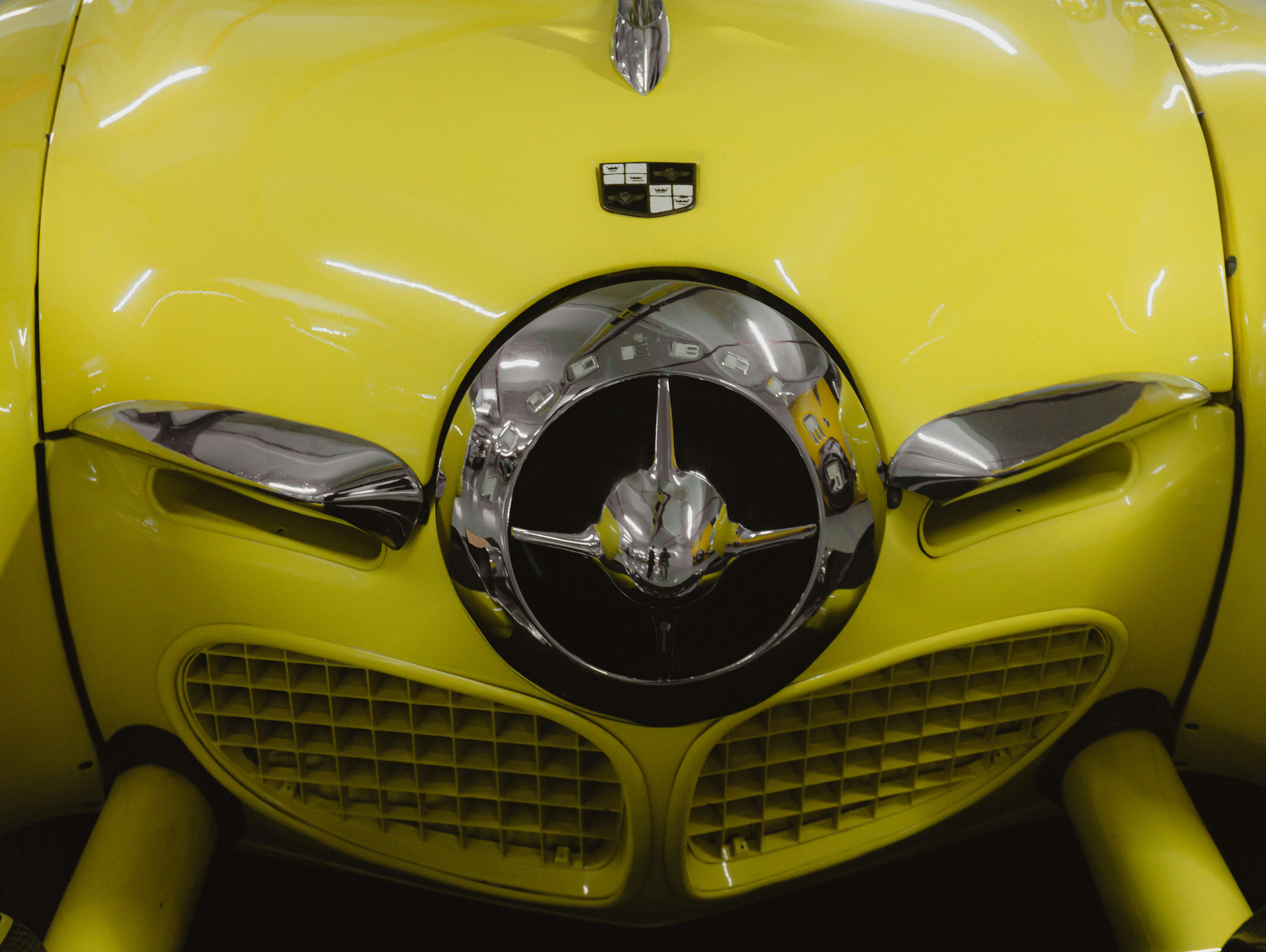 Close-up of a vintage yellow car grille