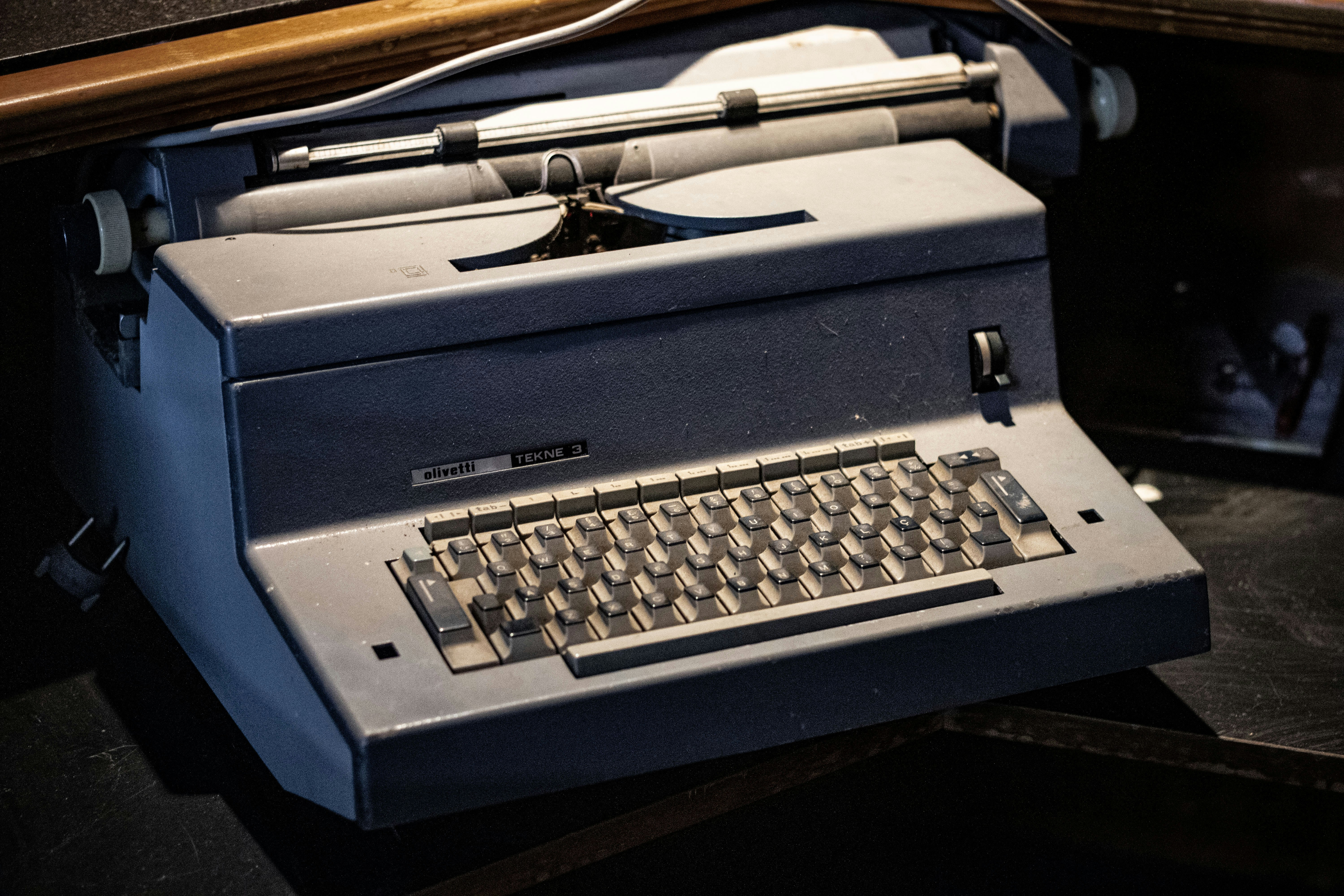 A vintage electric typewriter sits on a desk.