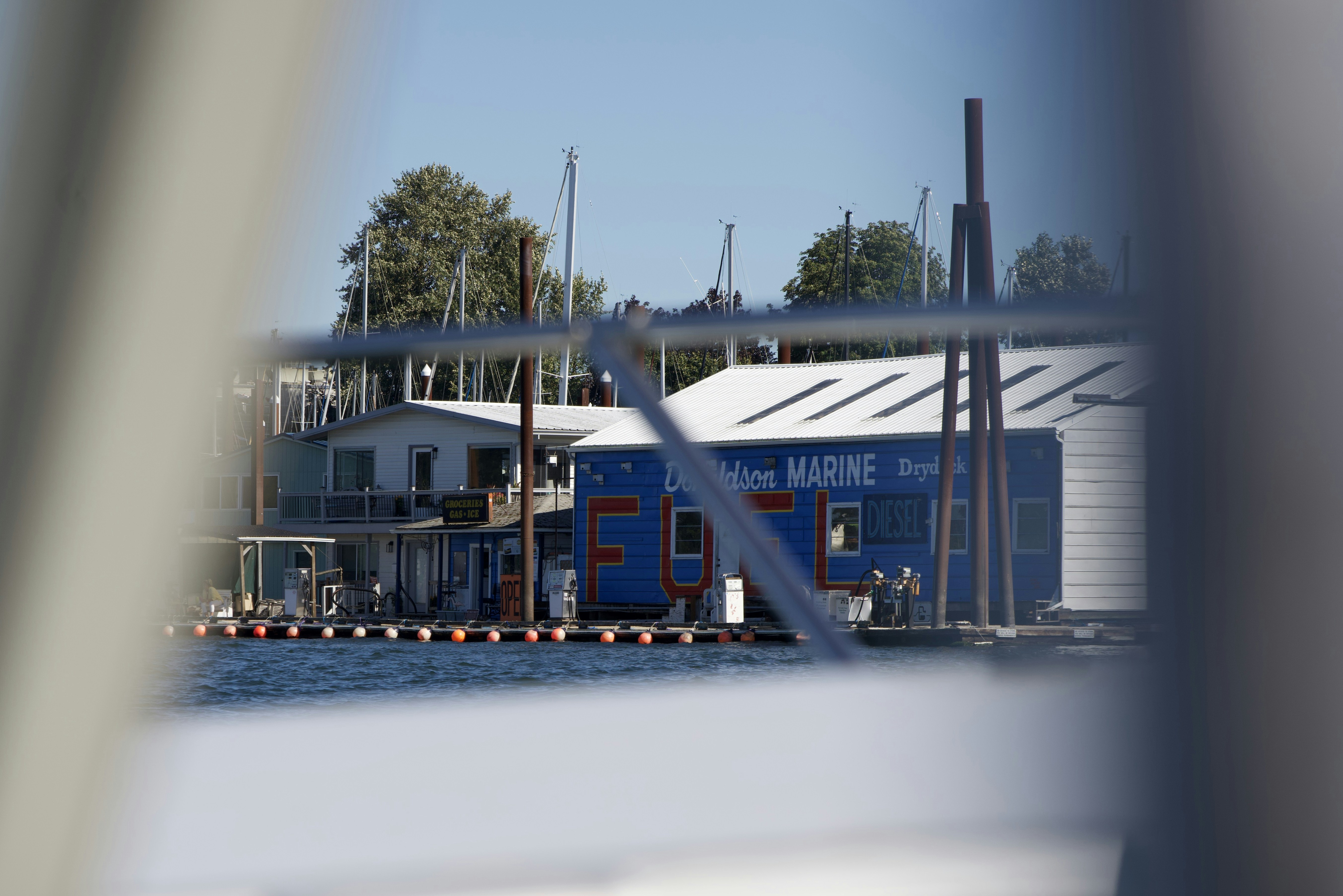 Boats docked at a harbor with buildings in background