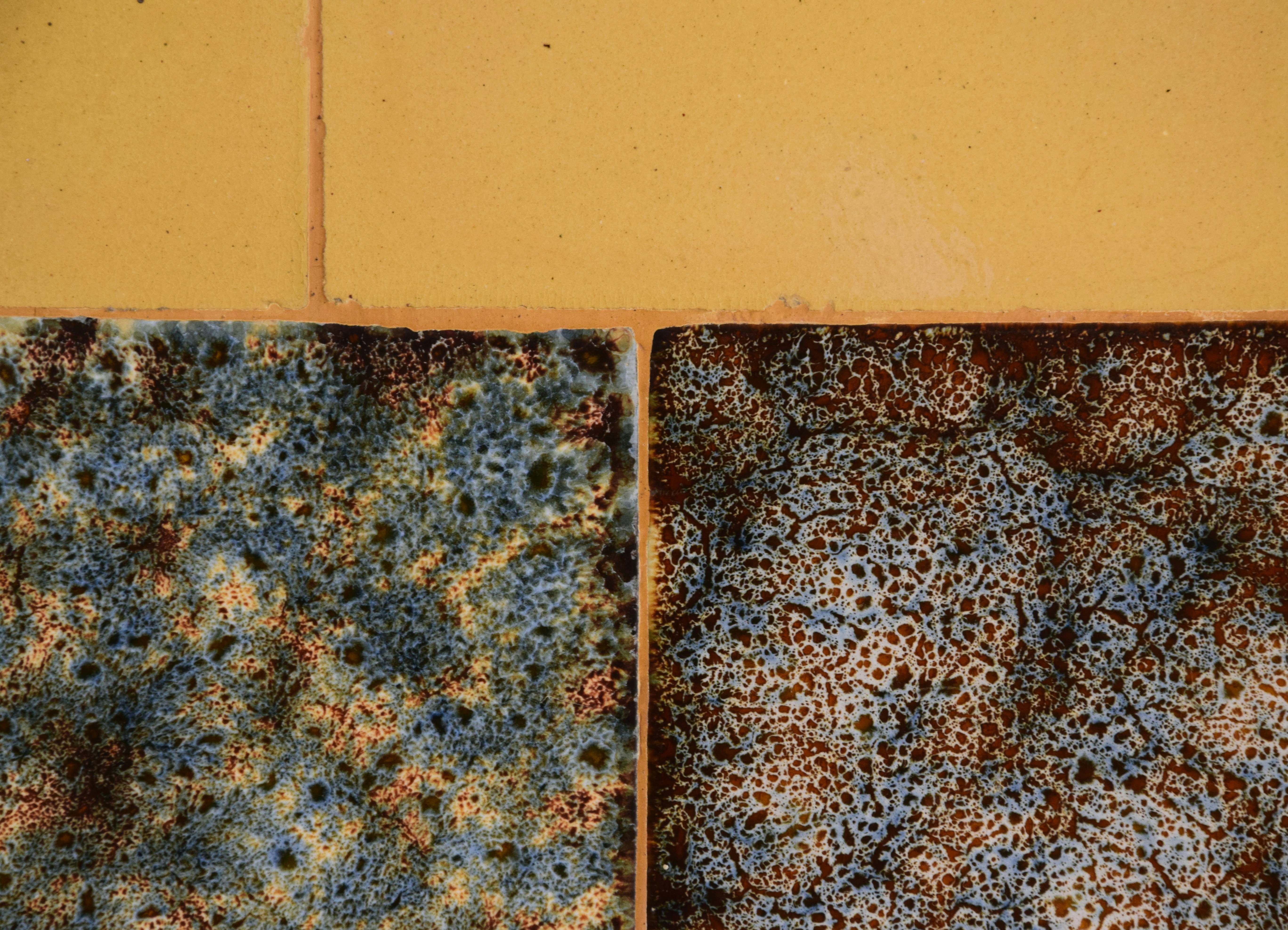 Split Surface: Weathered Rust Tiles Beneath a Sunlit Stripe