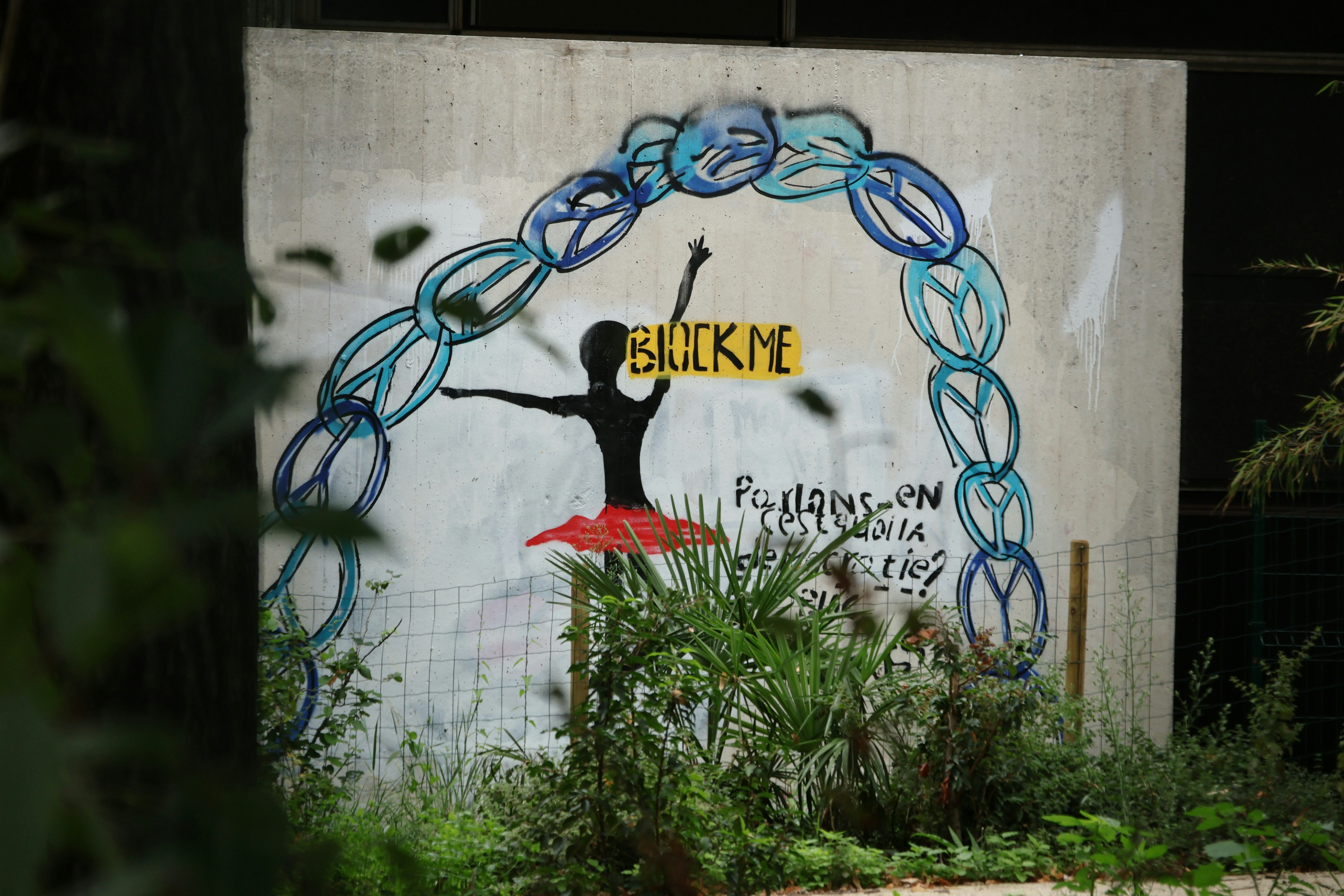 Dancer Under the Blue Chain Arc: A Graffiti Silhouette