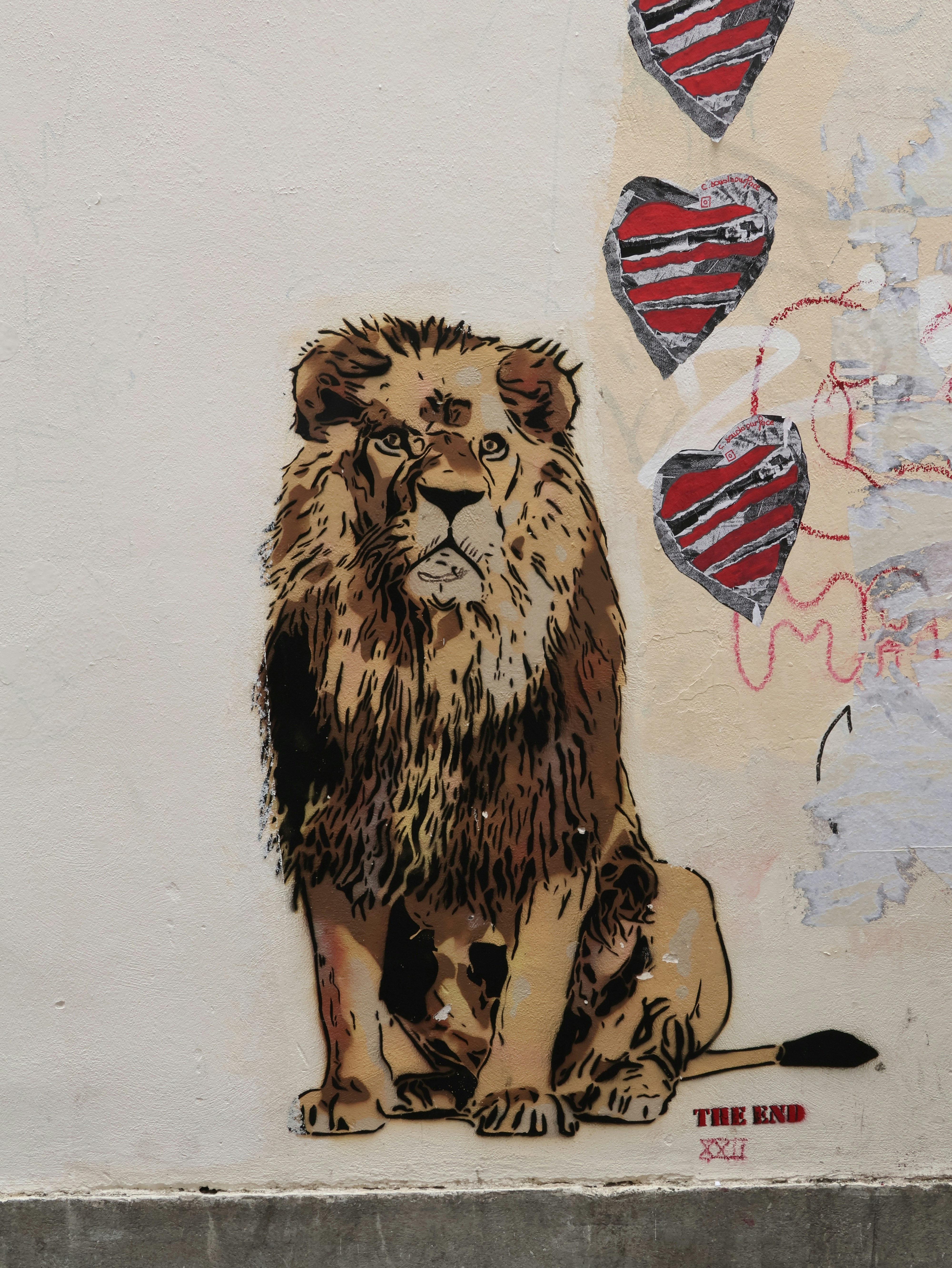 A majestic lion sits with hearts in the background