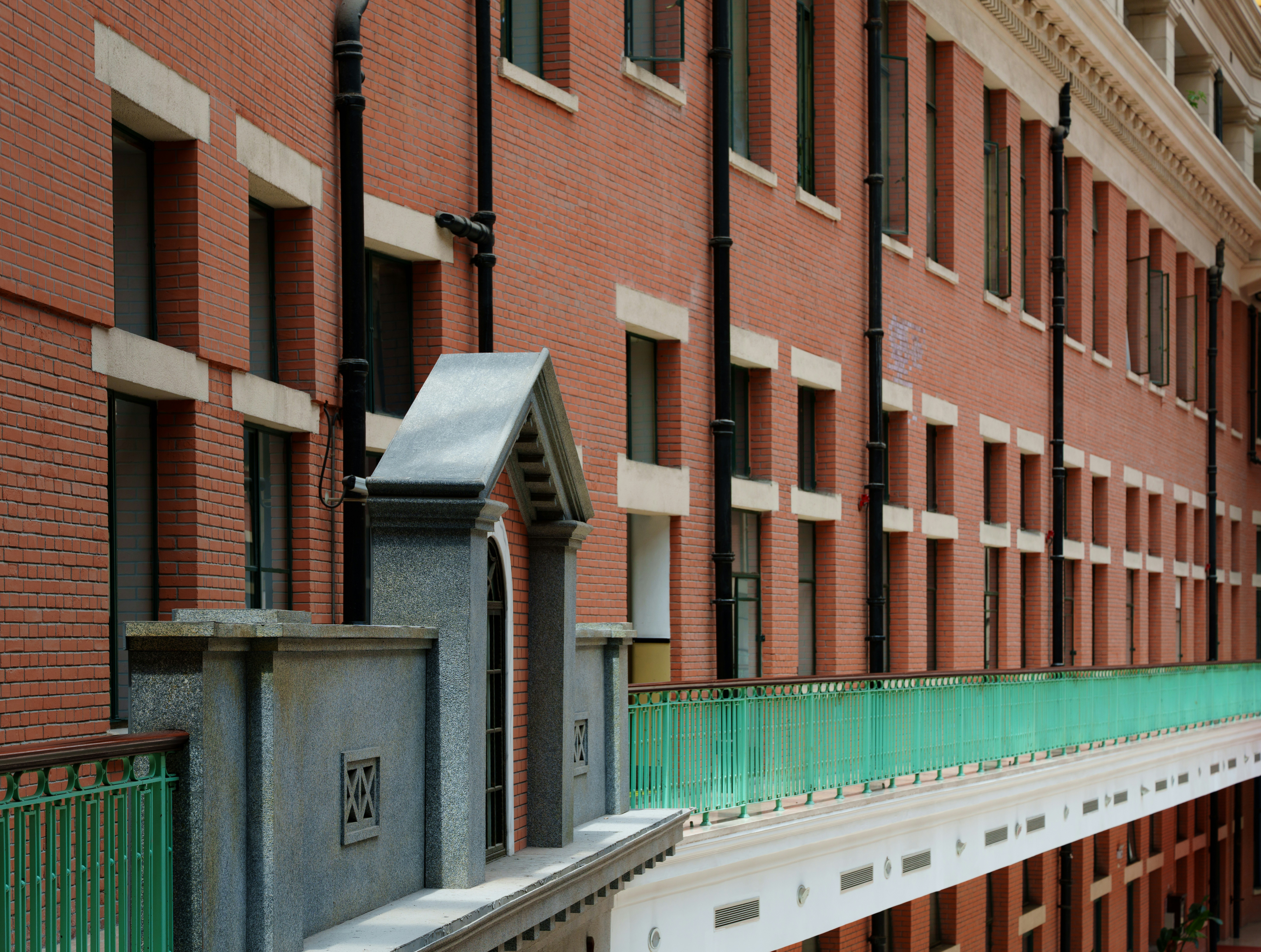 Brick Facade Highway: A Row of Red Townhouses with Green Balcony Accents