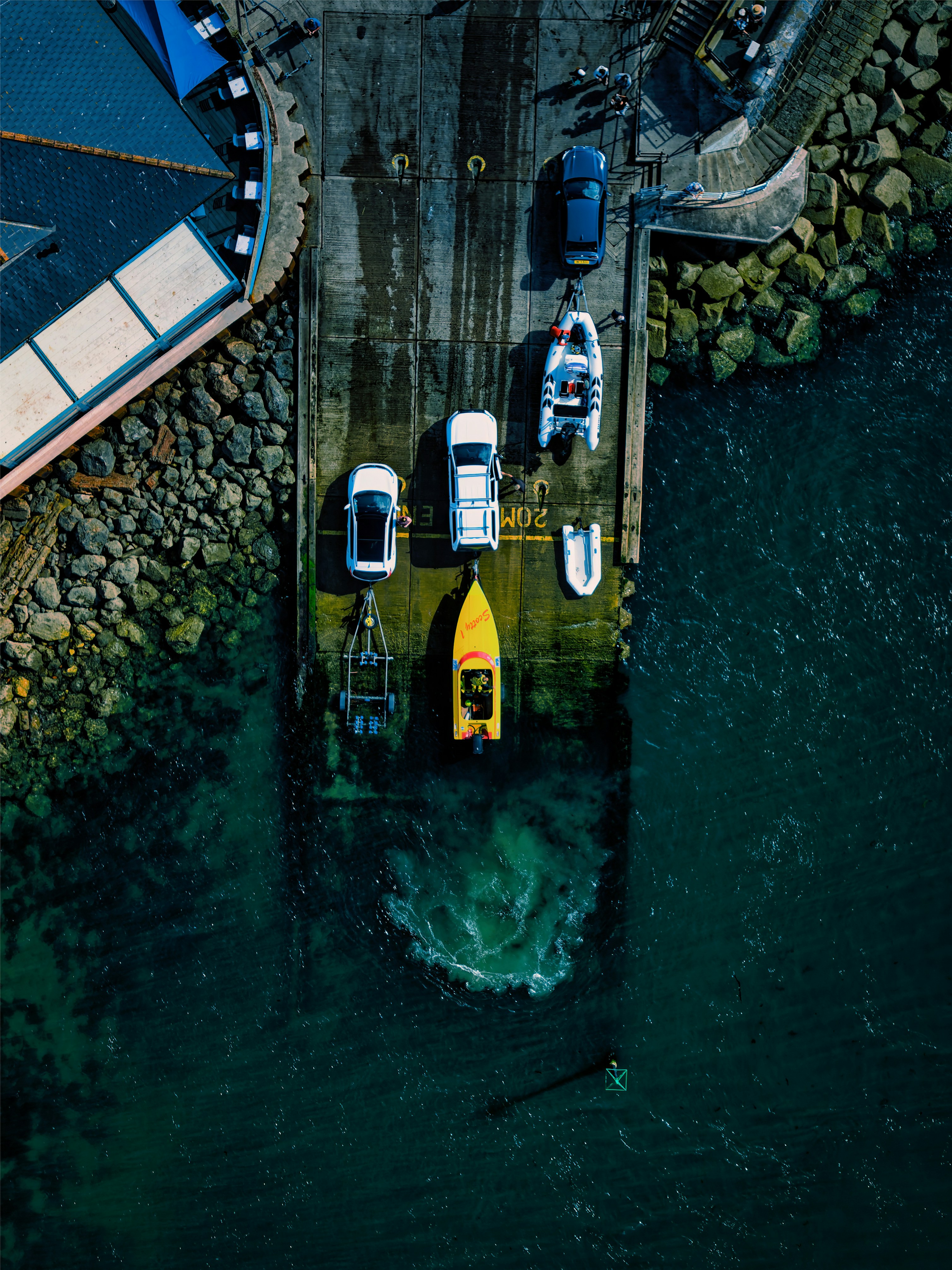 Pull Me Up. Busy slipway on a hot summer morning, Exmouth Marina, Devon, UK | Several boats docked at a waterfront ramp.
