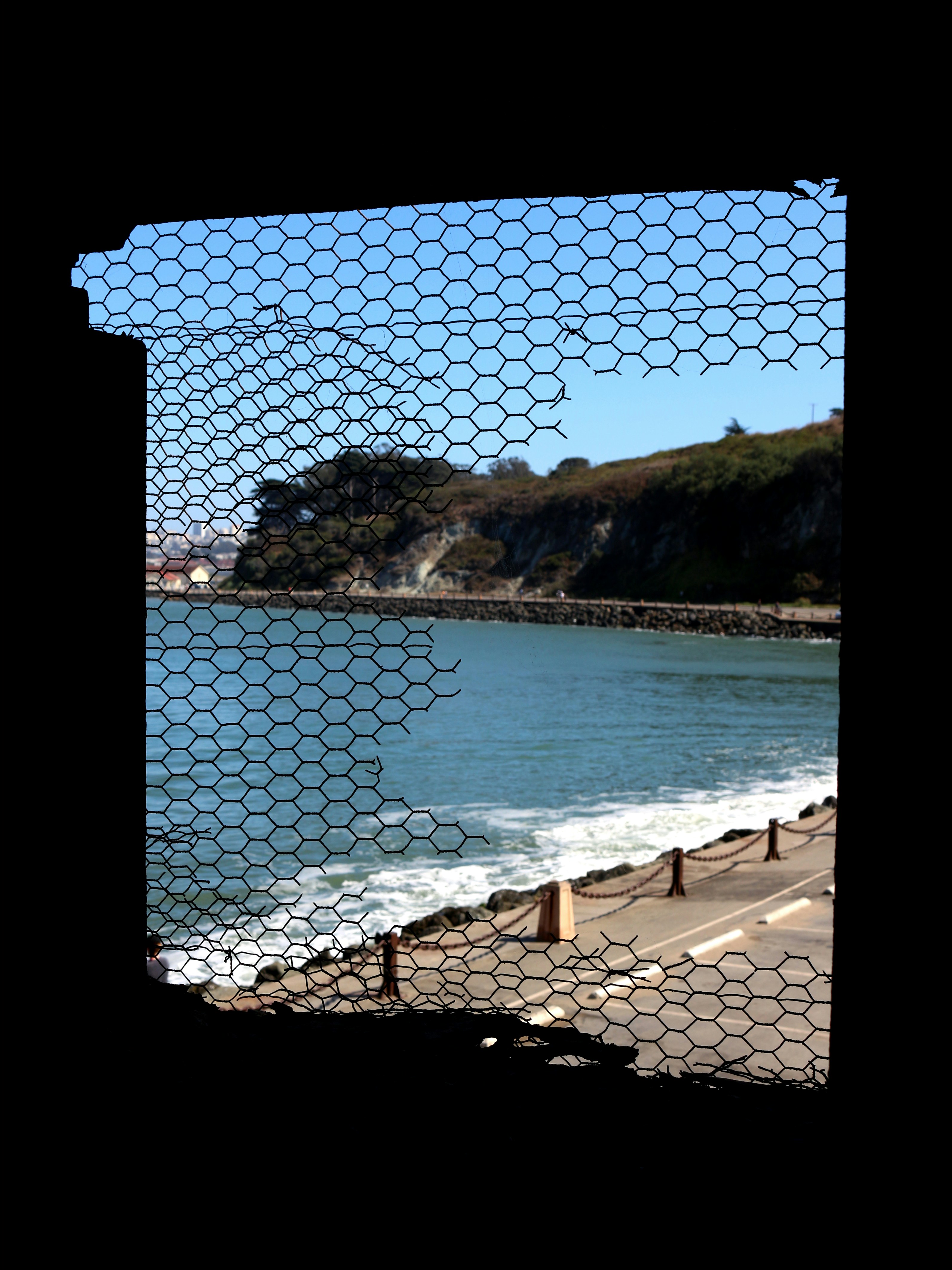 Framed Serenity: A Coastal View Through the Mesh