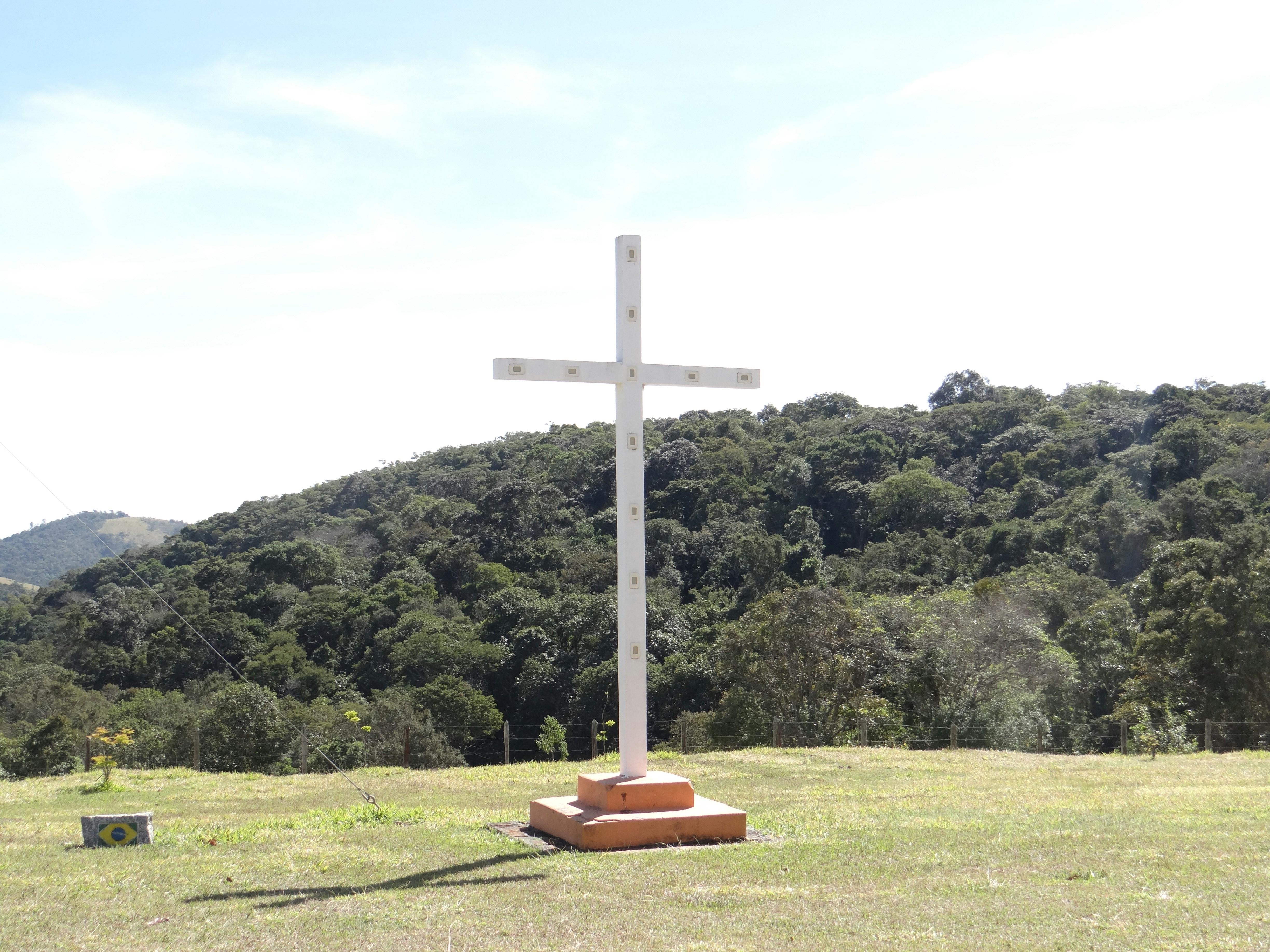 Silent Sentinel: A Cross Amidst Nature's Embrace