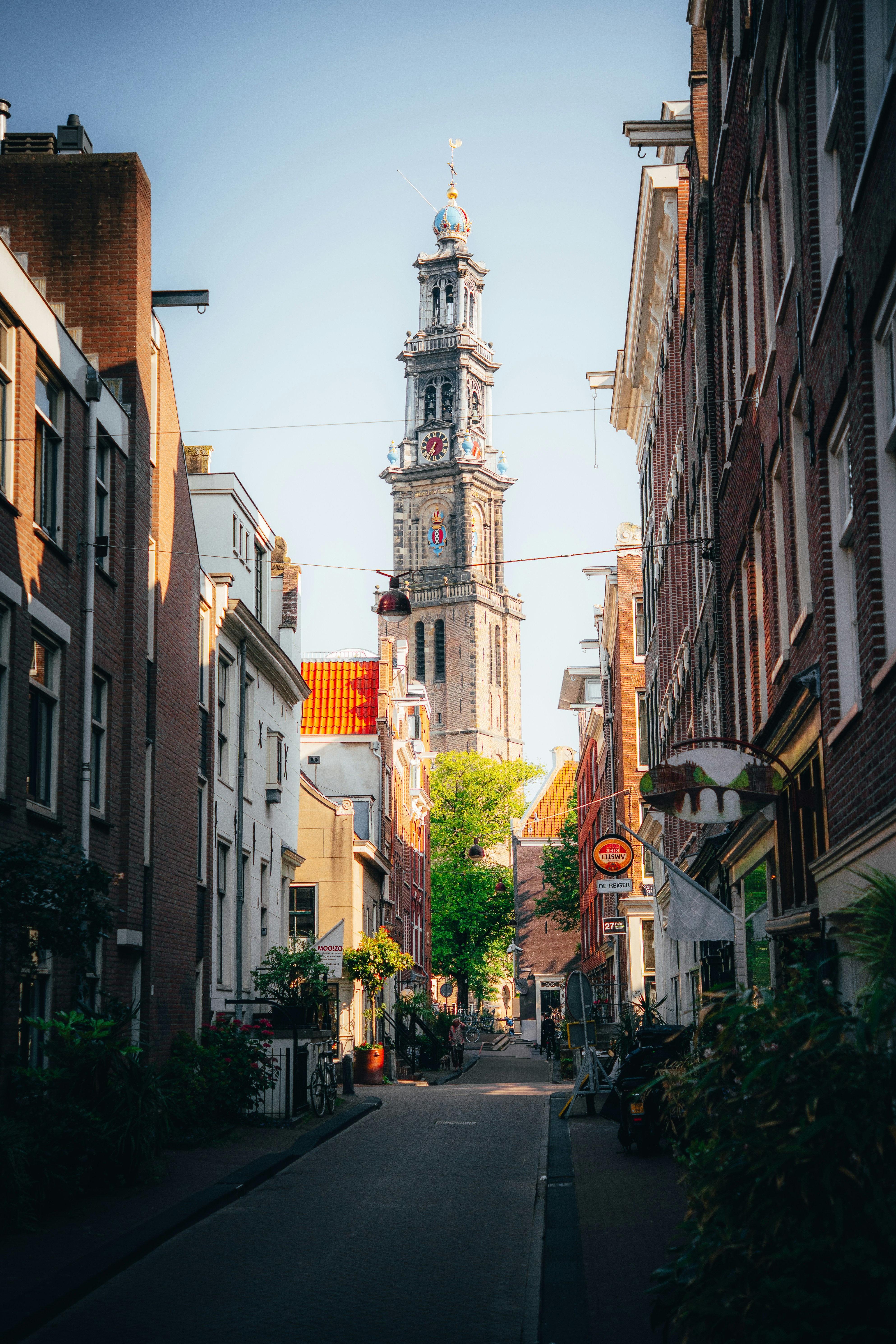 Tall church tower viewed down a narrow street. photo – Free City Image ...