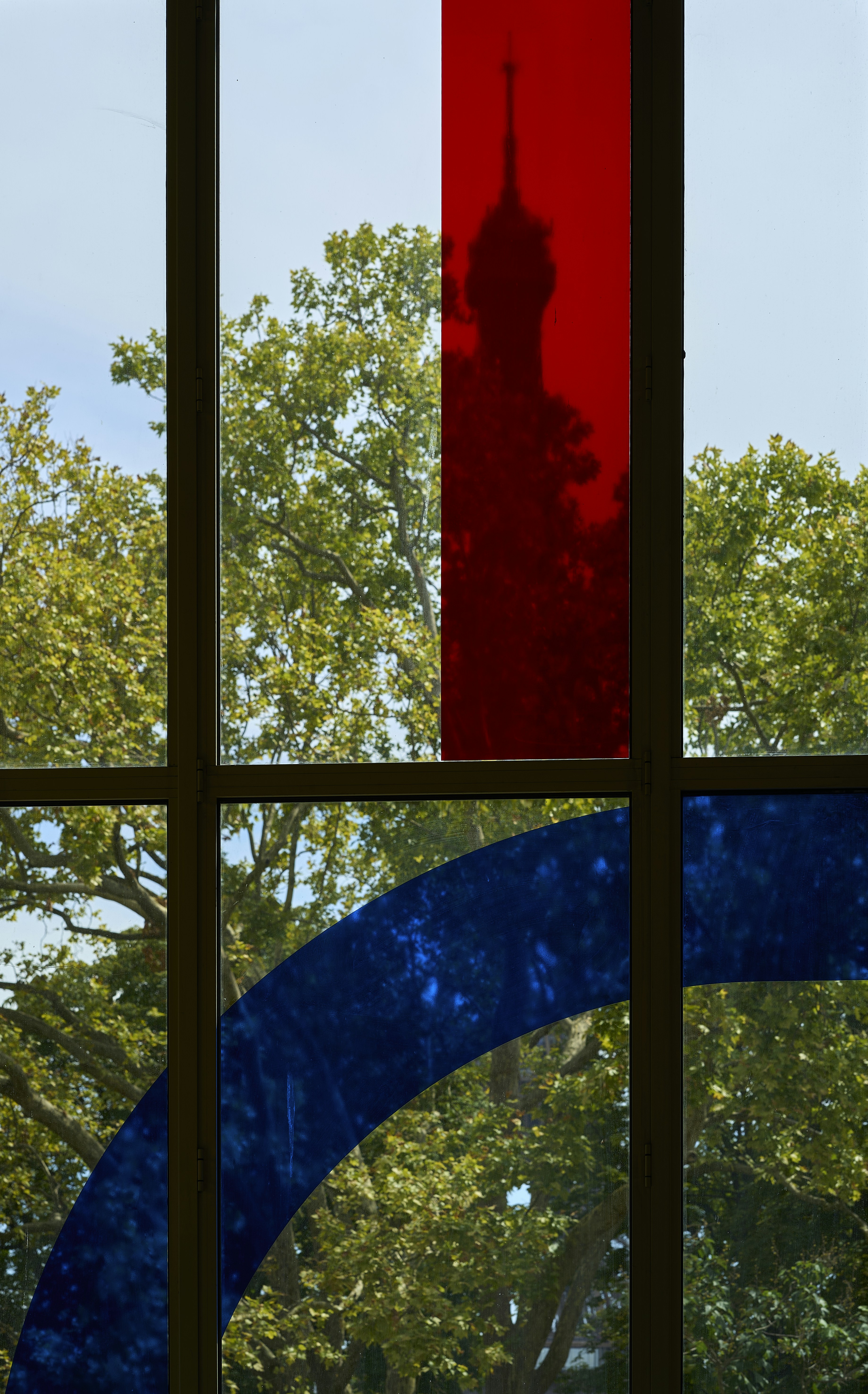 Stained Glass Window Fragments Framing a Sunlit Terrace