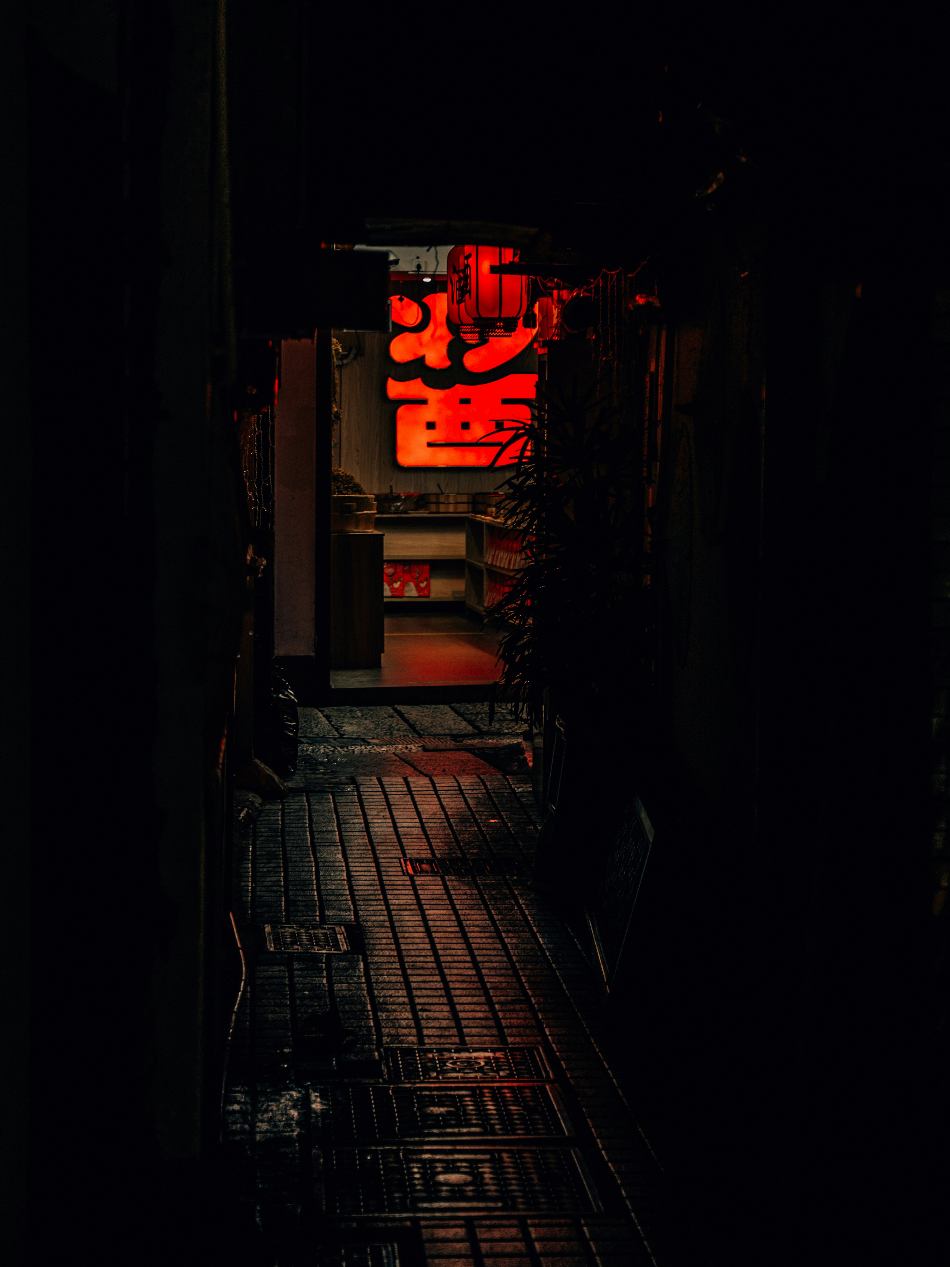 Dark hallway with glowing red light at the end