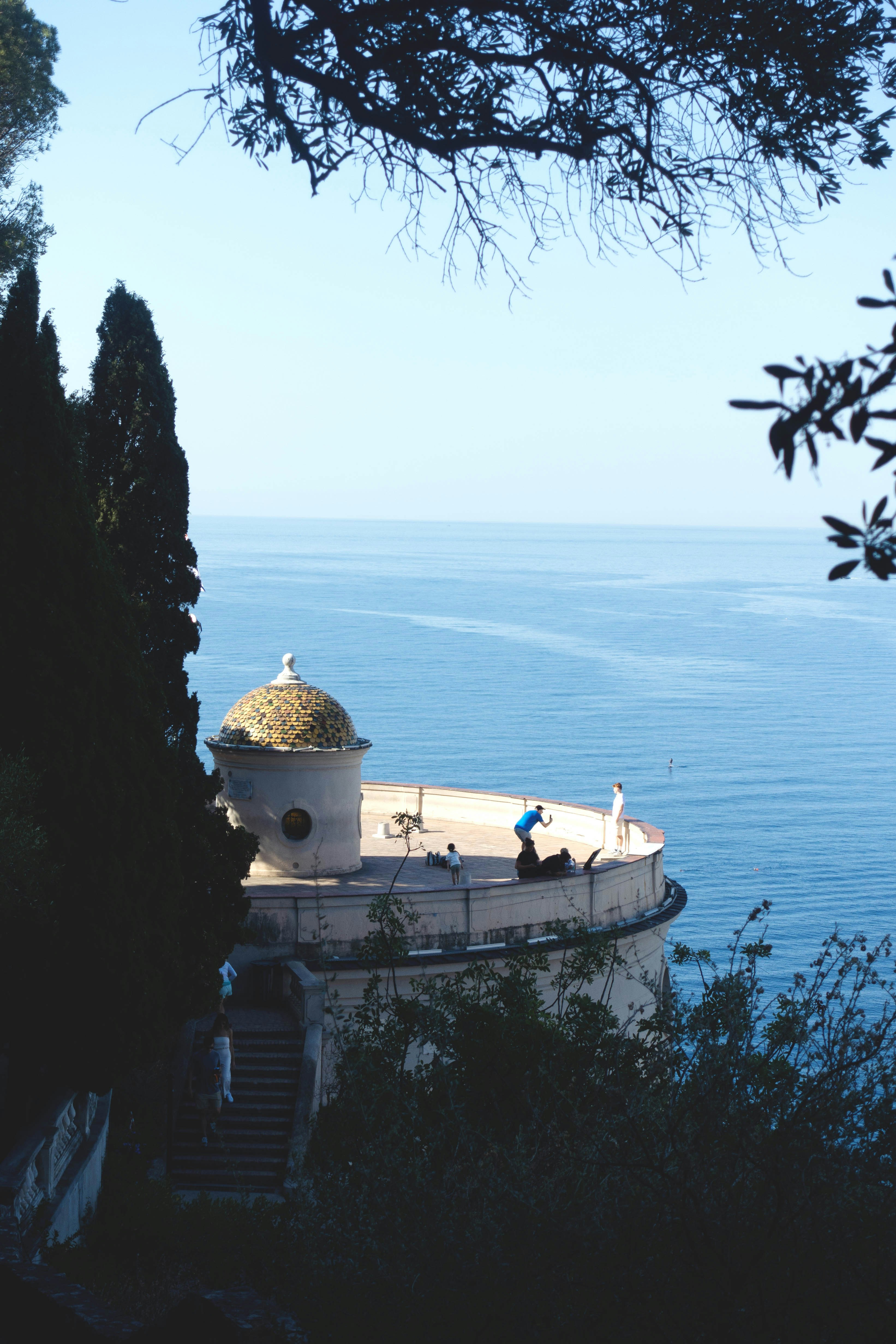 Coastal building with dome overlooking blue ocean water