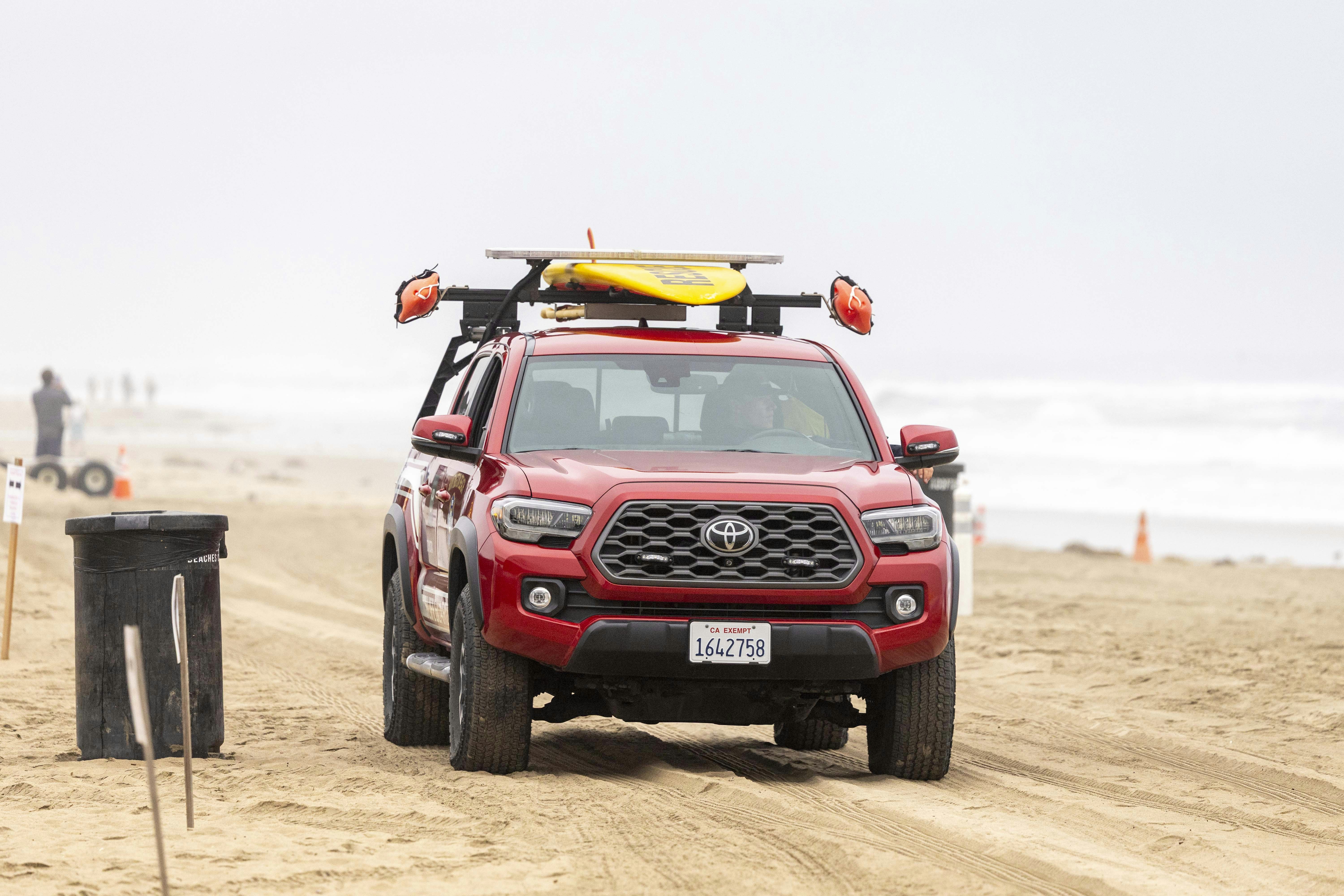Red Tacoma on the Beach Run: Surfboard Roofload and Sunlit Dunes