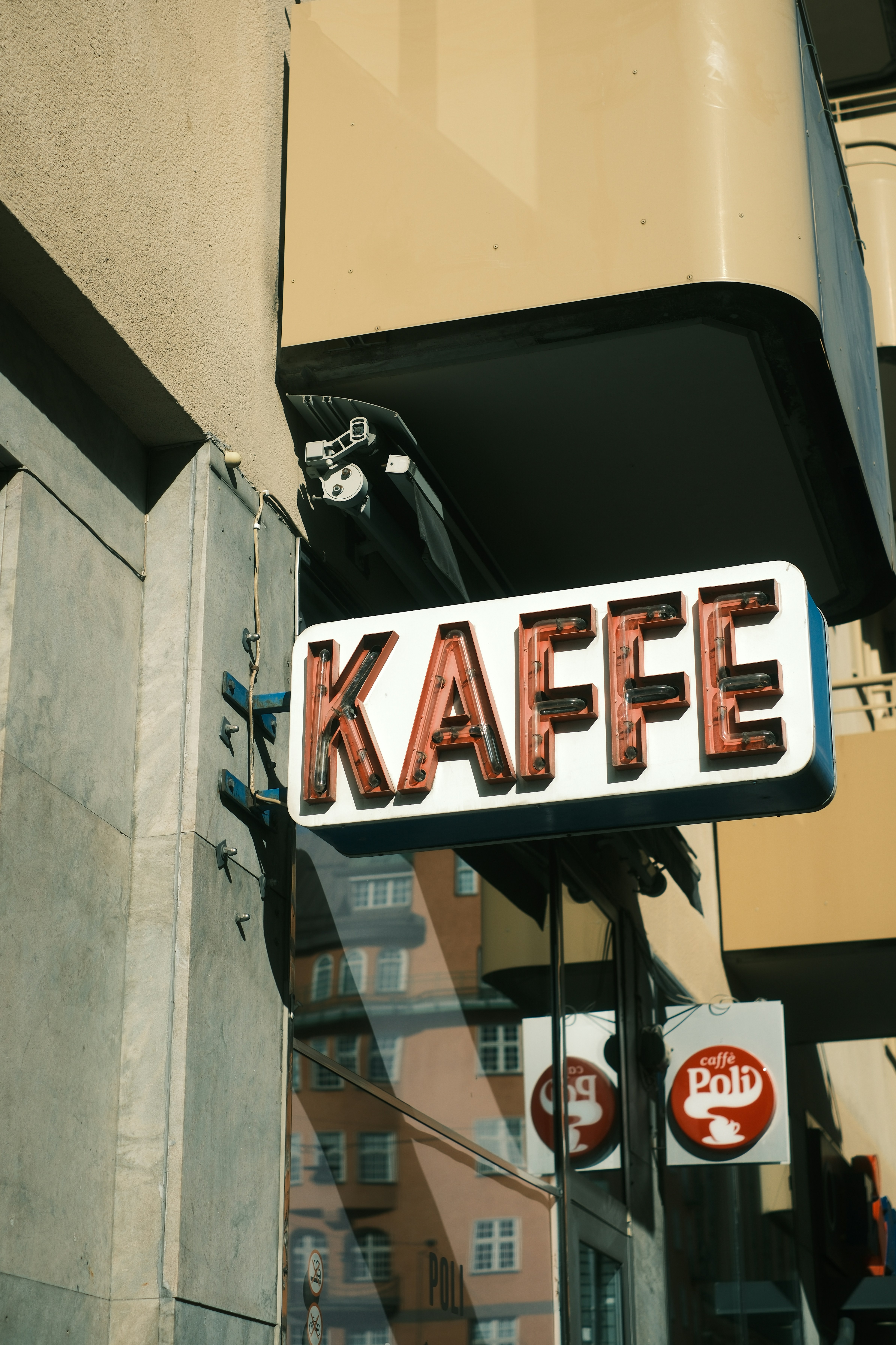 A retro style cafe sign in Fridhemsplan, Stockholm, Sweden. | Illuminated kaffe sign on a building exterior