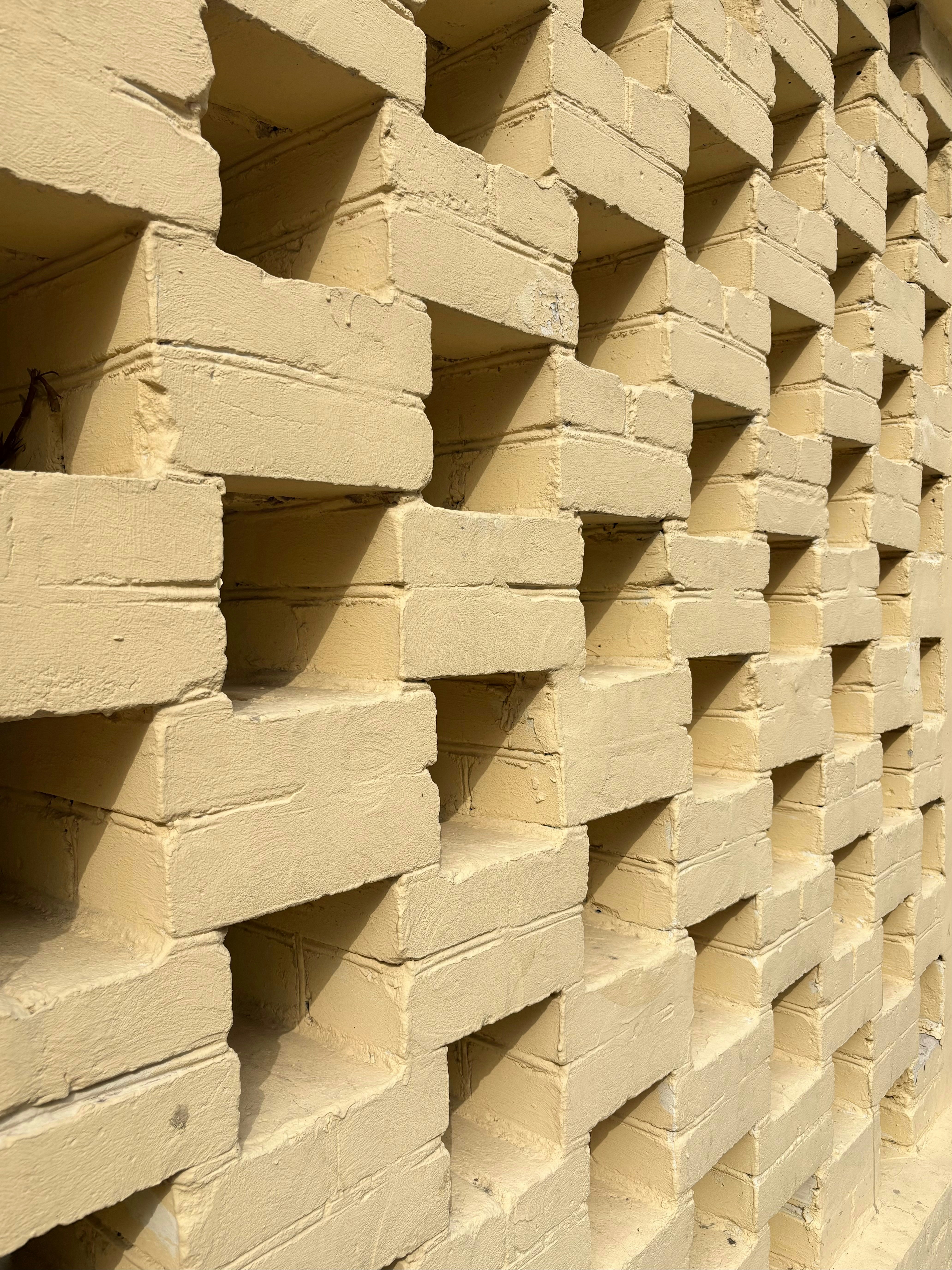 Stacked light yellow bricks forming a pattern
