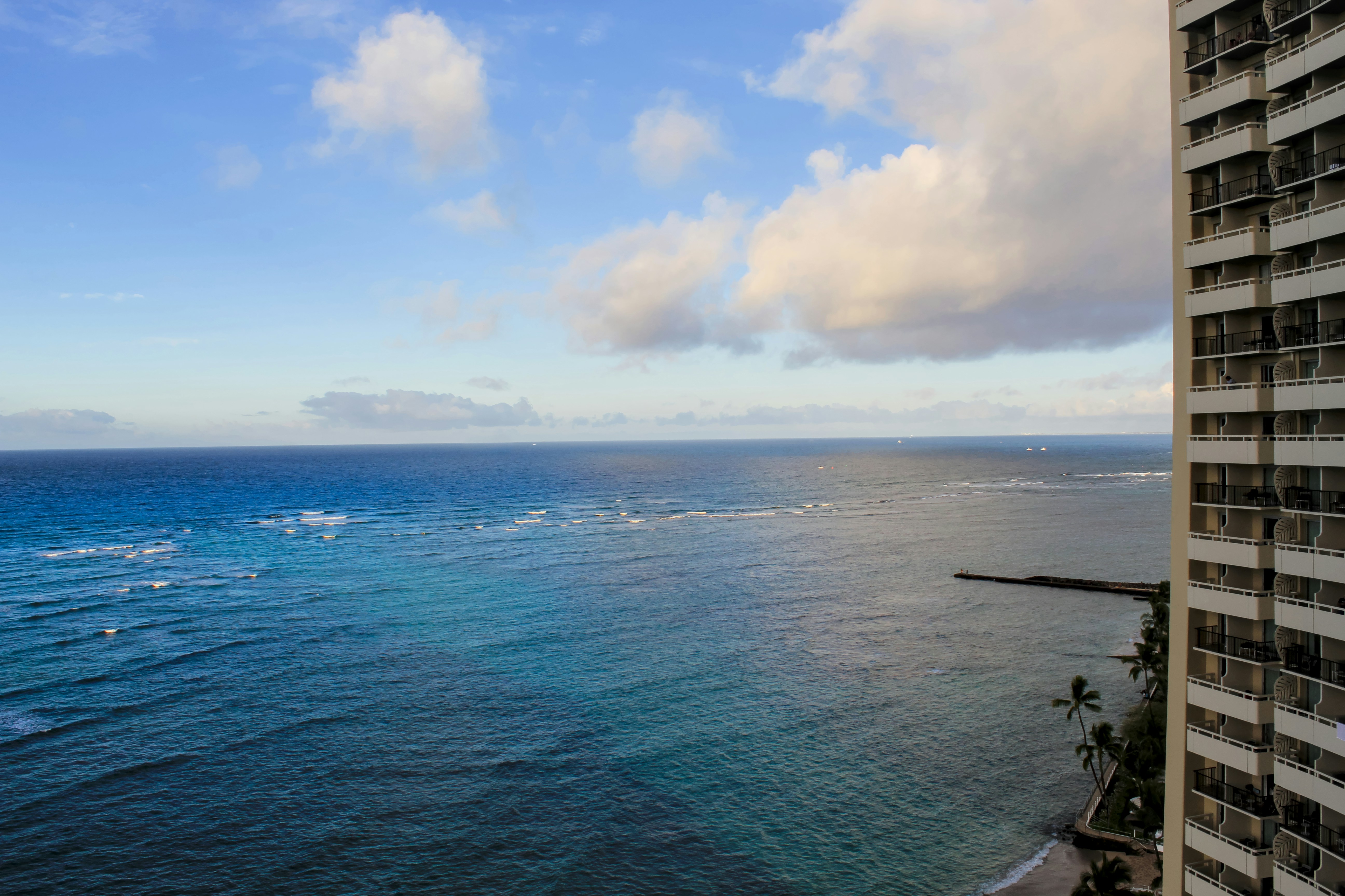 Ocean view from a high-rise building balcony.