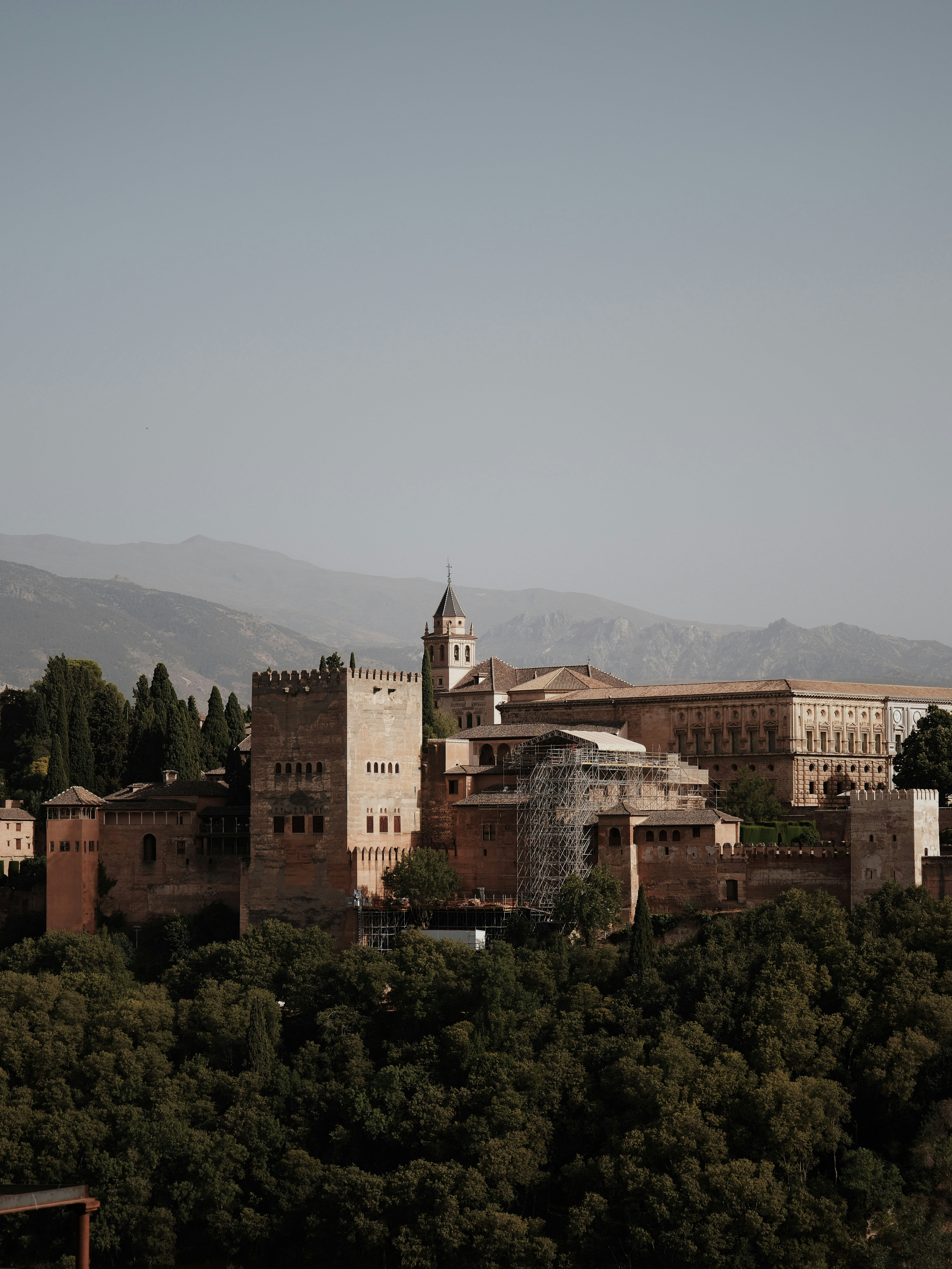 Historic fortress complex nestled among lush trees