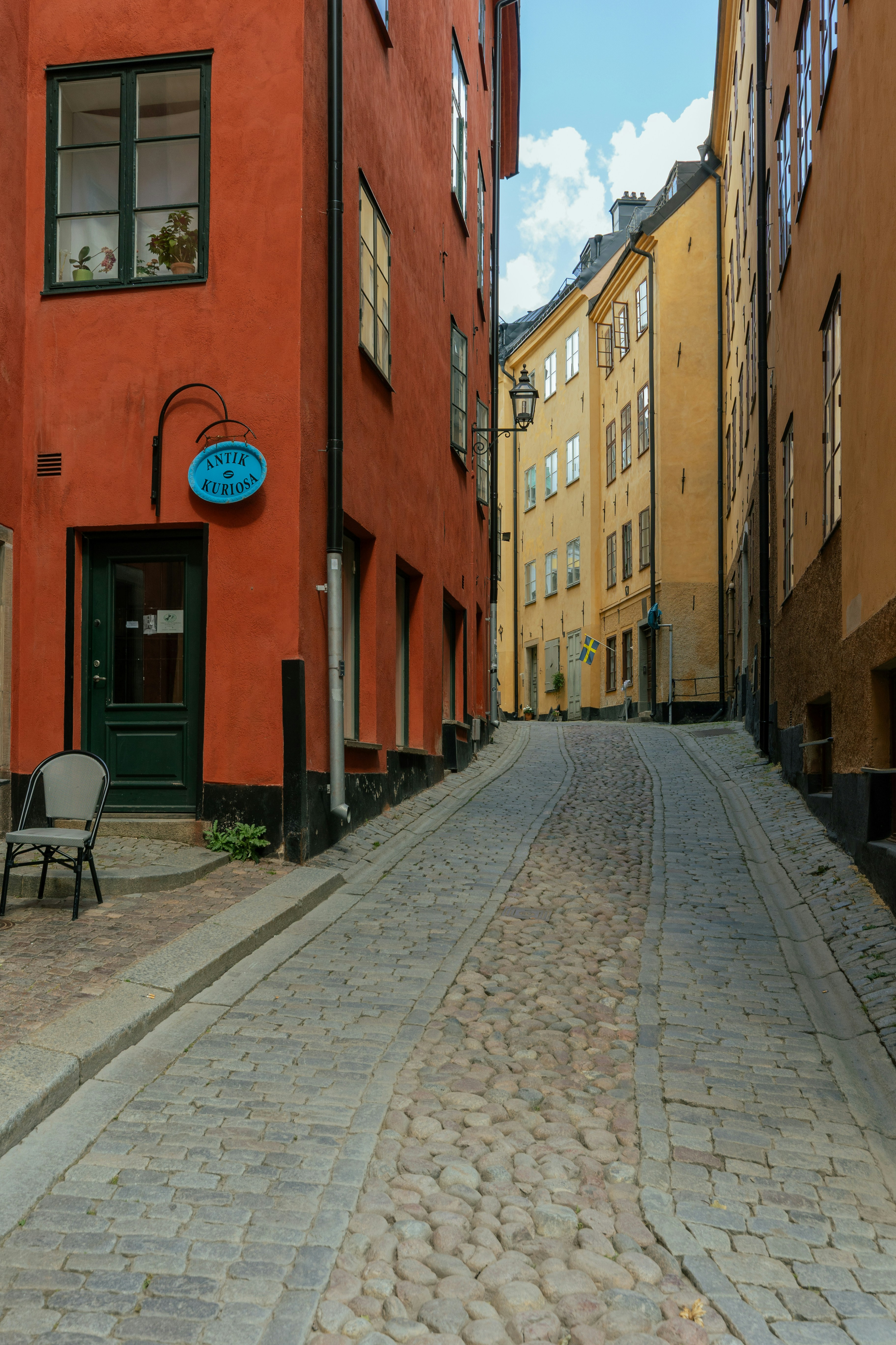 Cobblestone street between colorful old buildings