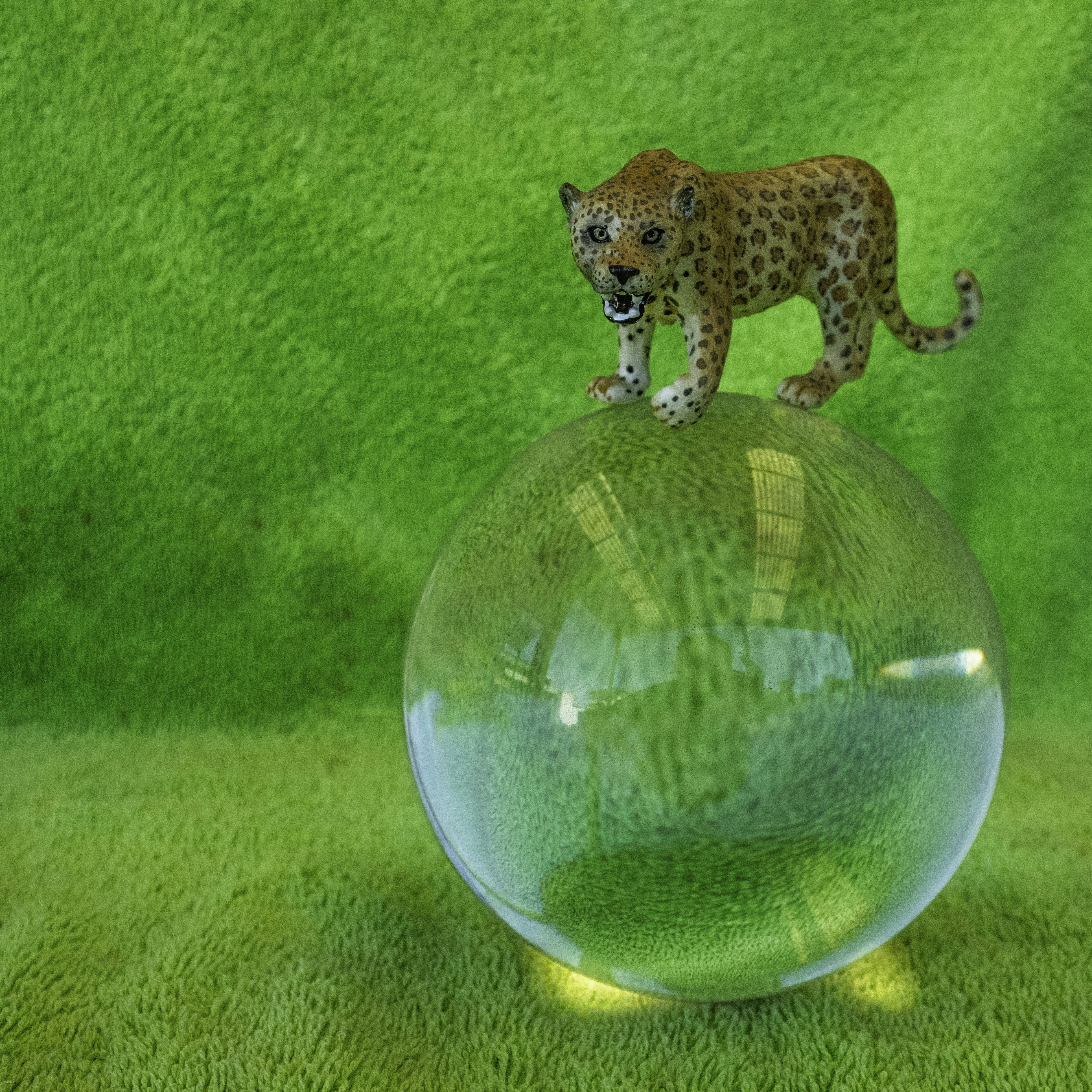 Leopard on a Crystal Ball: A Tiny Predator in a Luminous Green Studio