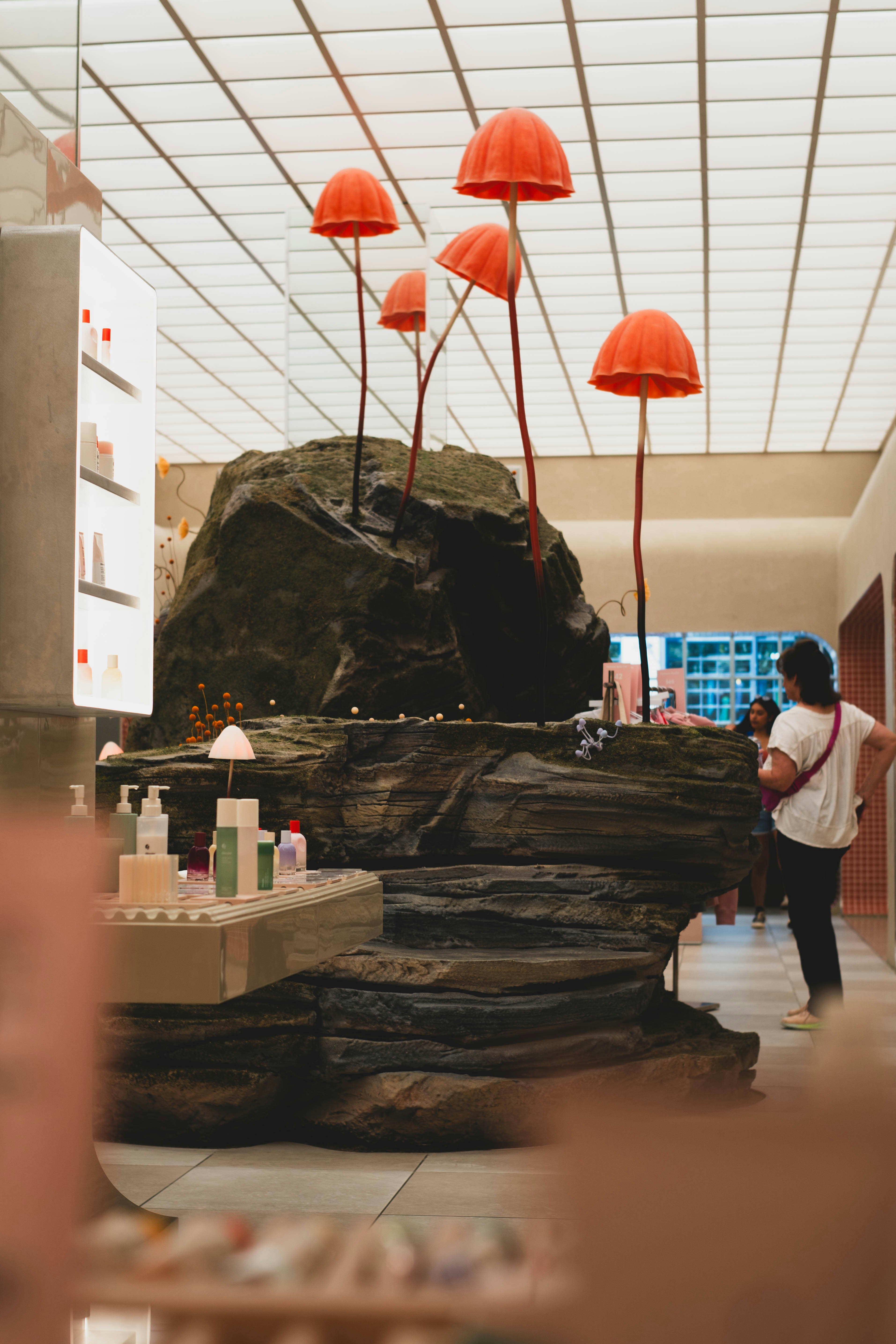 Red Lanterns on a Rocky Pedestal in a Modern Indoor Display