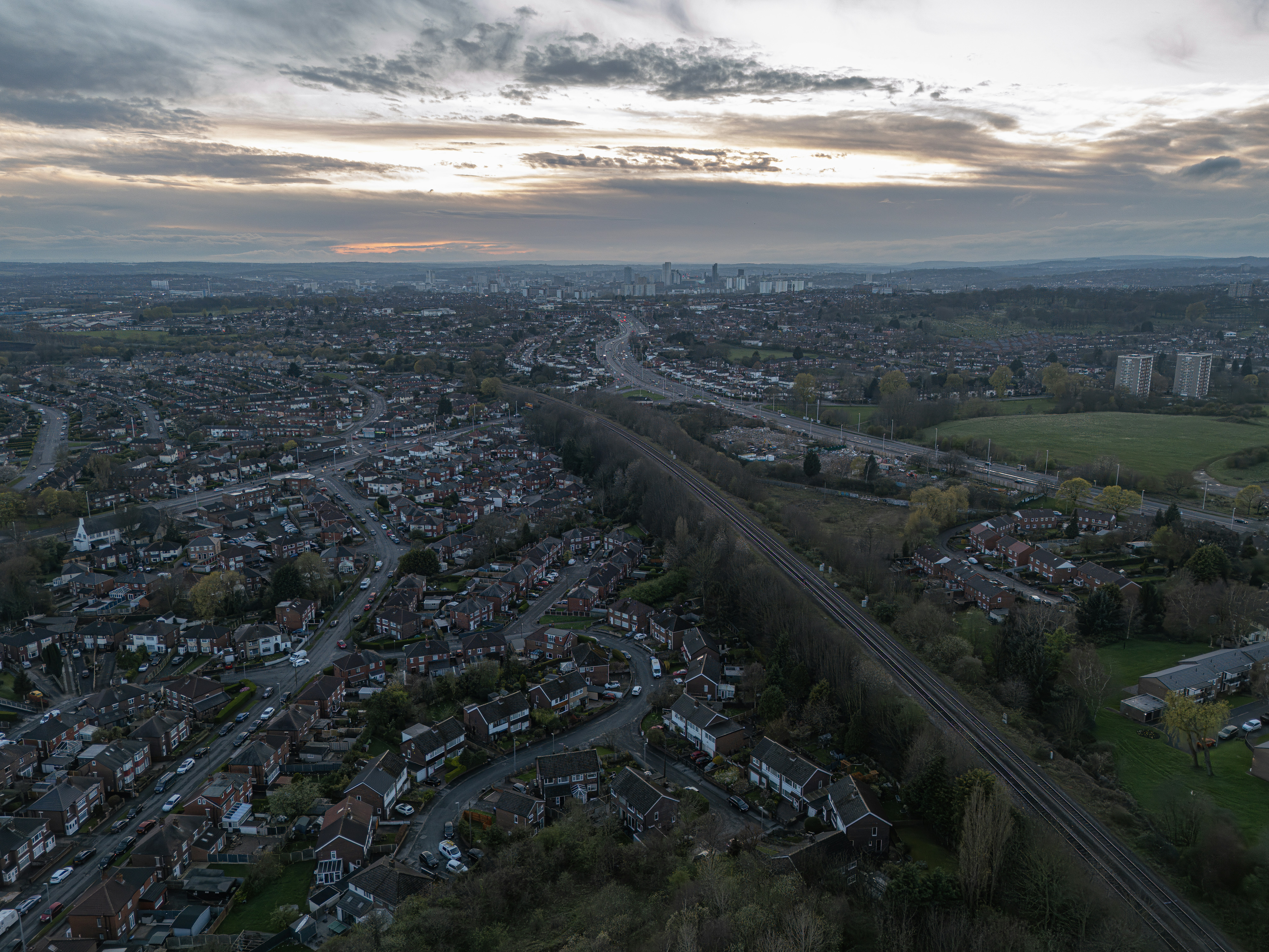 Aerial view of a sprawling suburban landscape at dusk.
