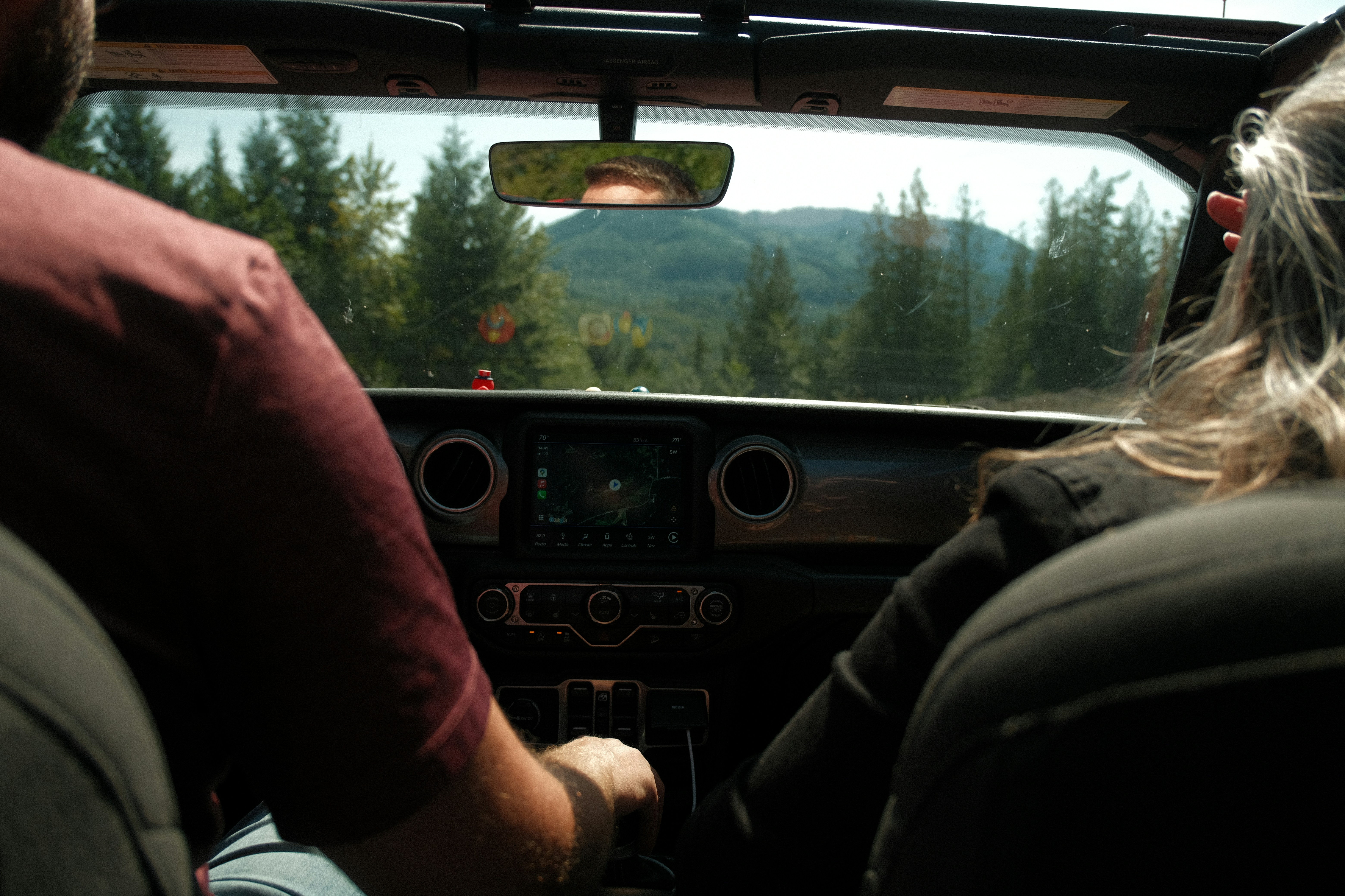 Off-roading | Couple driving through a scenic forest landscape.