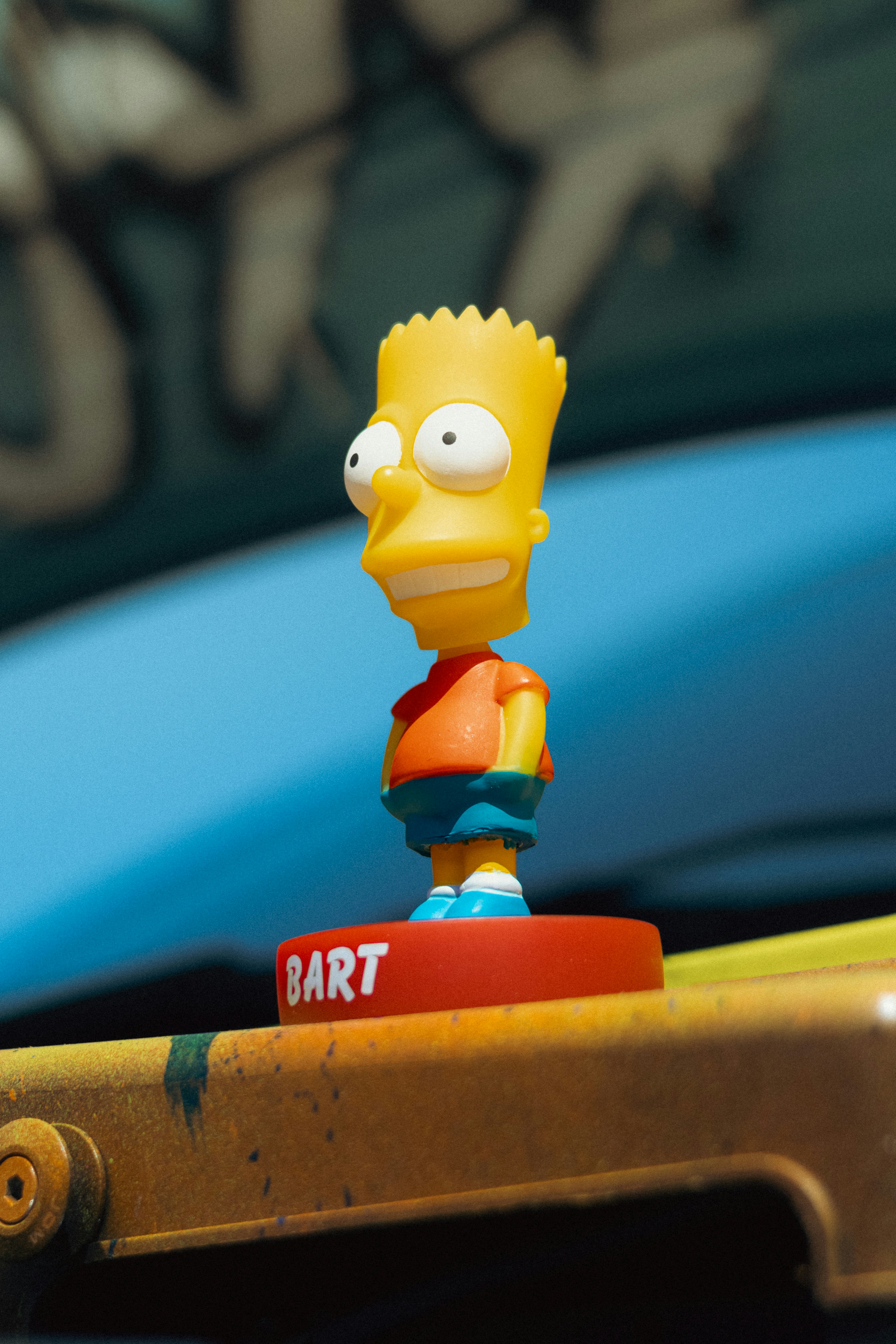 Bart simpson bobblehead on a yellow surface