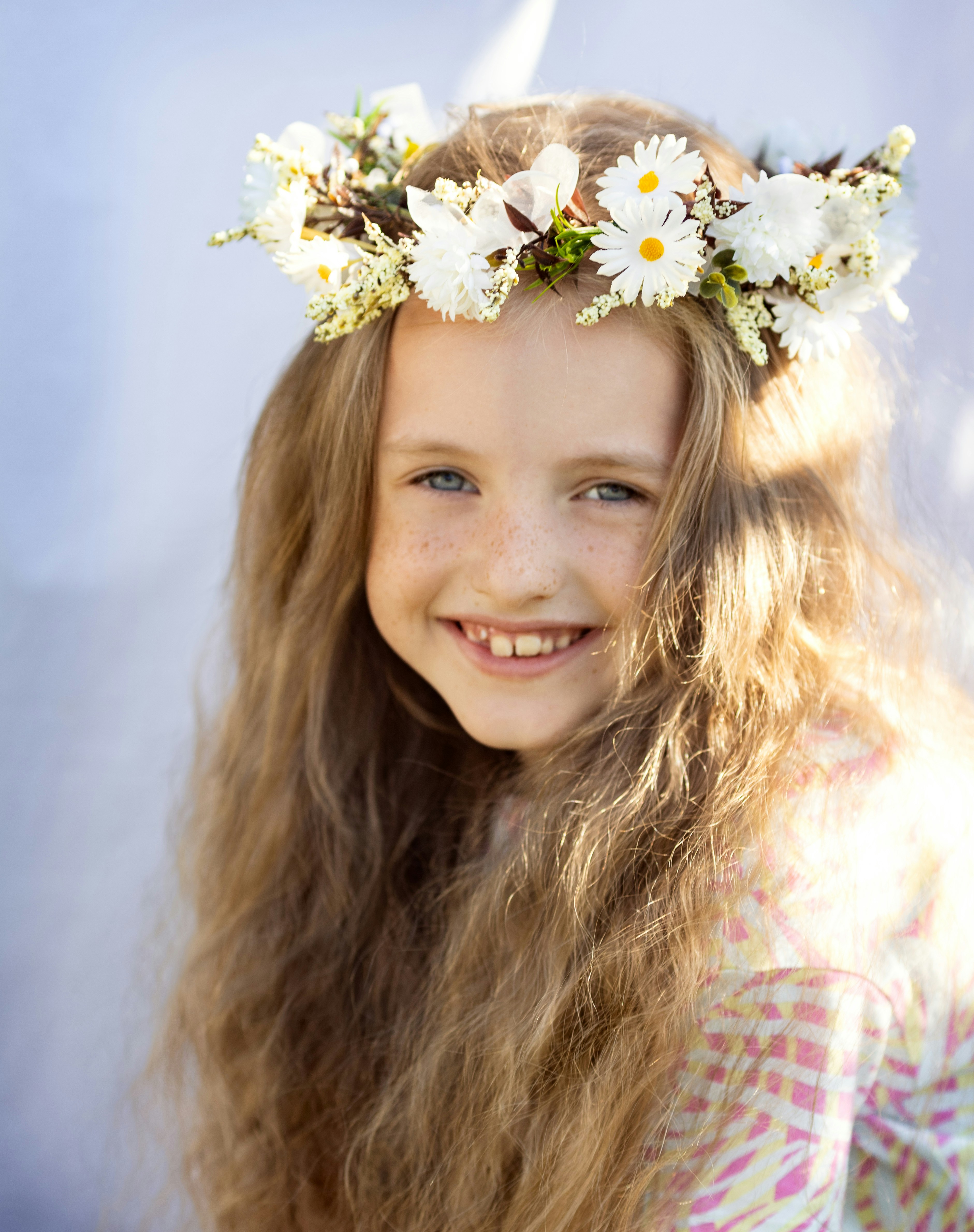 Young girl with flower crown smiles brightly