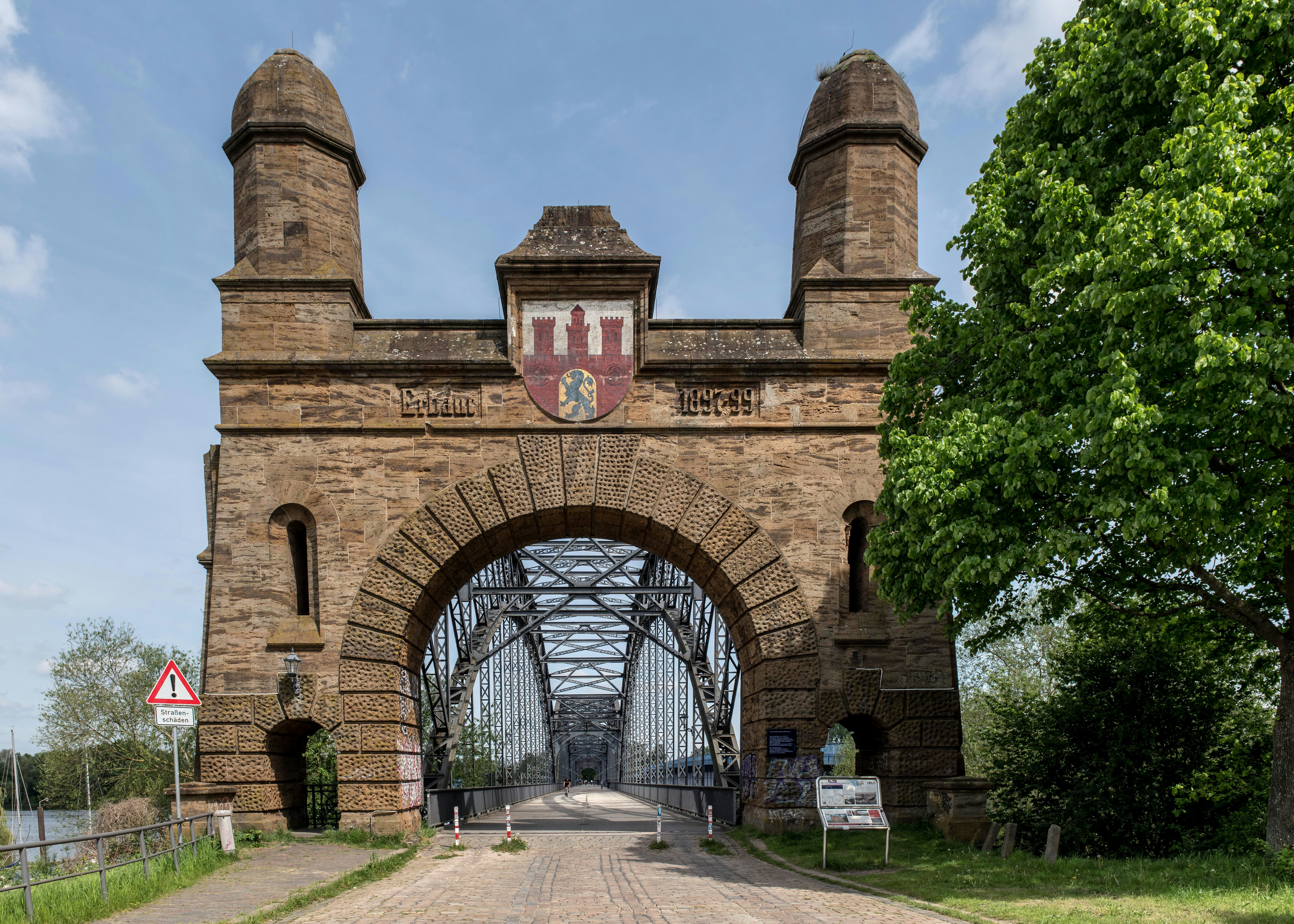 Stone gatehouse with arched bridge beyond photo – Free Transport Image ...
