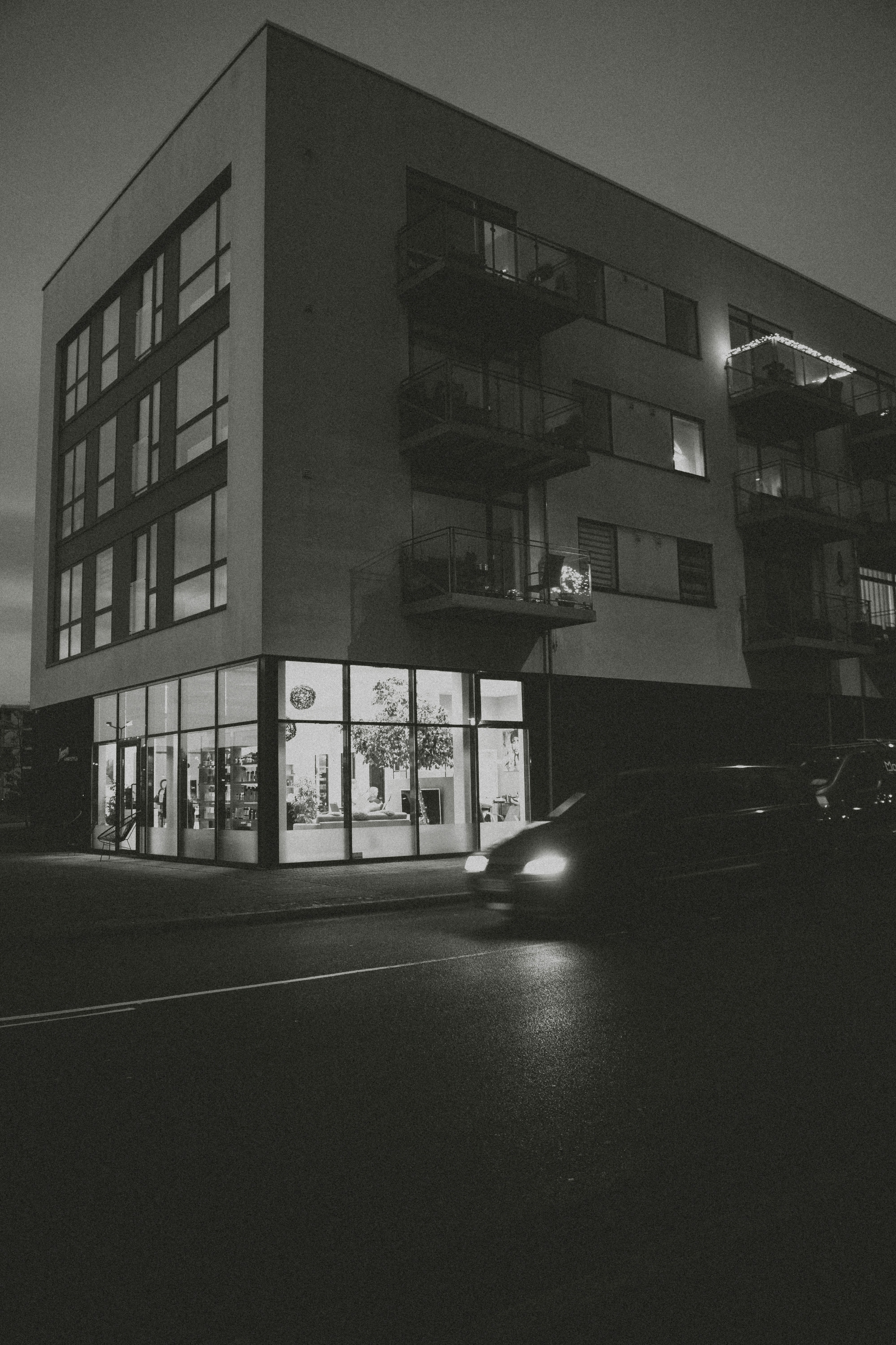 Modern building with glowing storefront at night