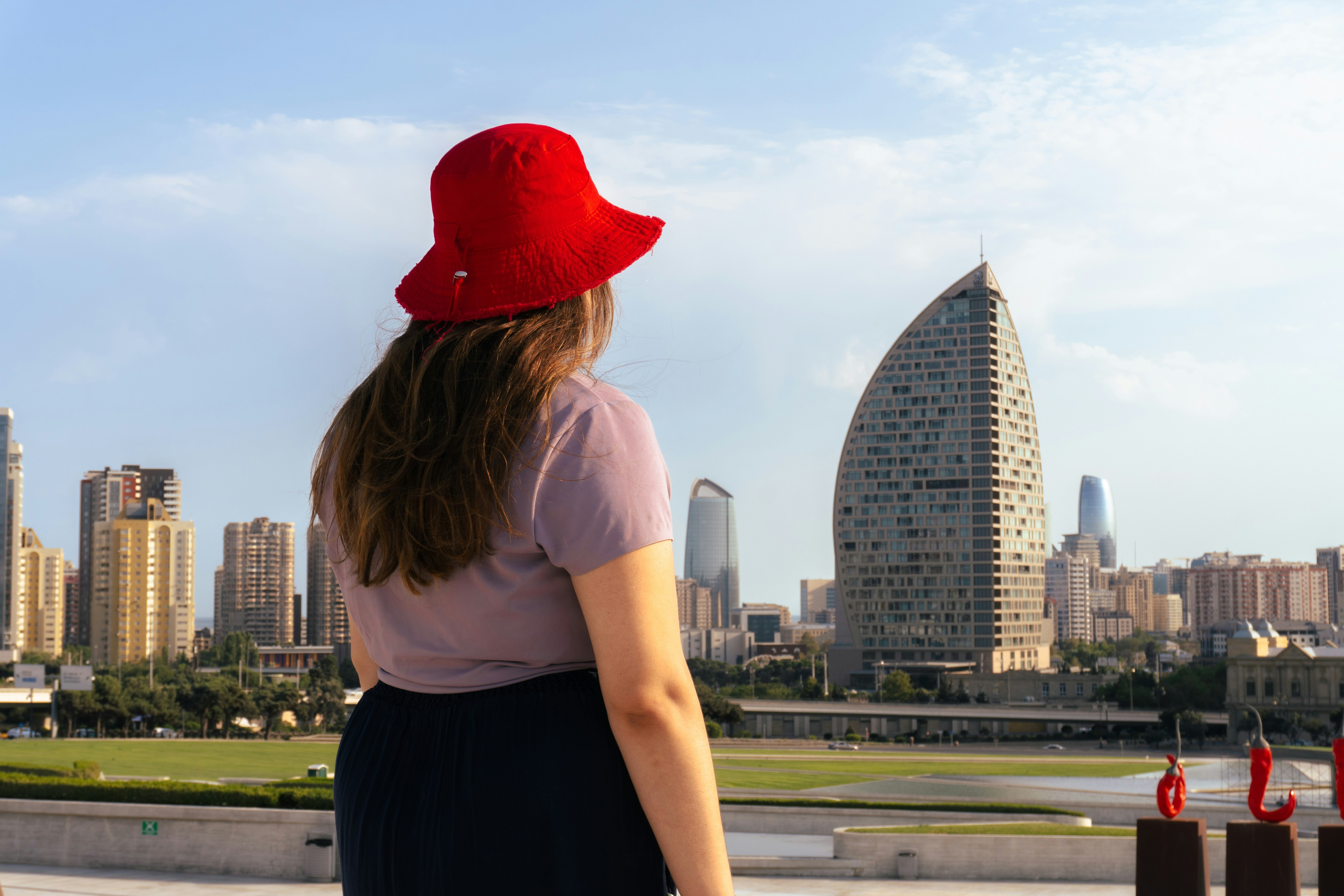Red Hat, Cityscape: A Woman in Profile Overlooked by Modern Architecture