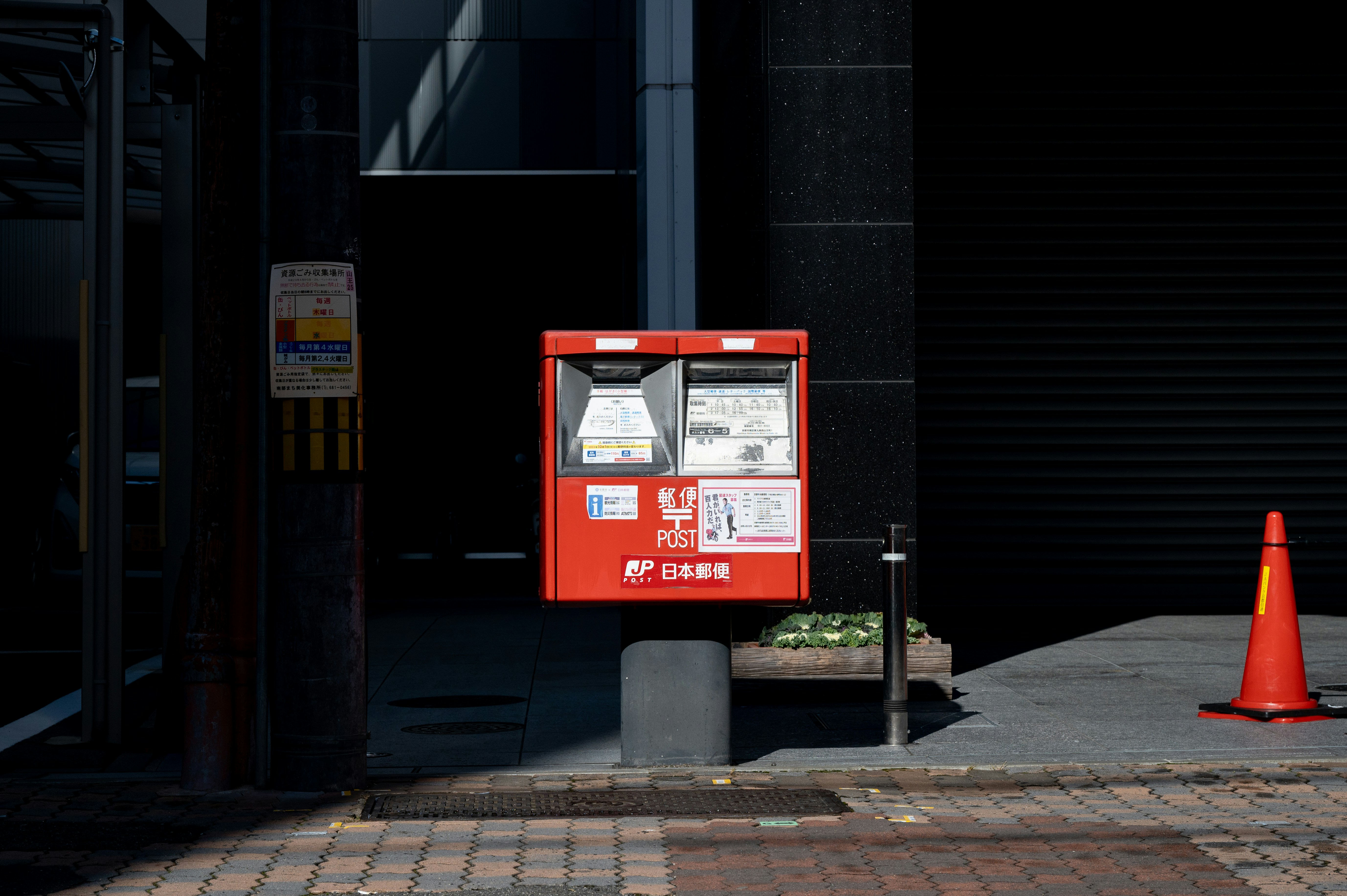 Red japanese post box on a city street