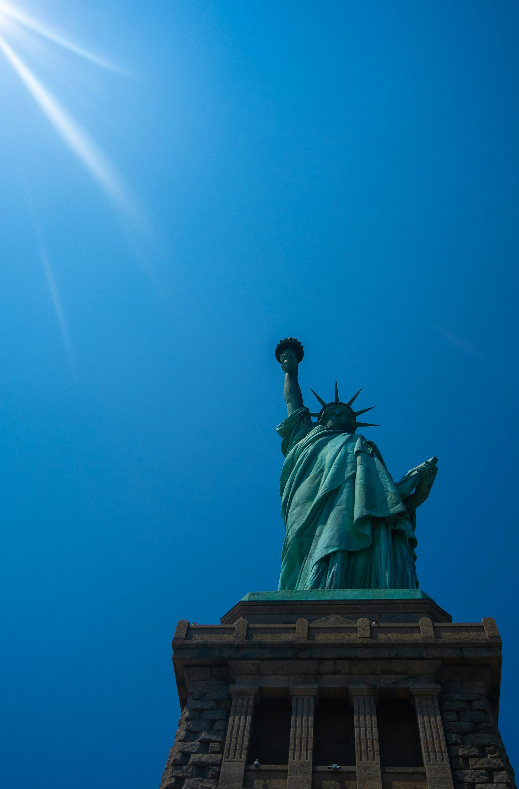 A Sentinel of Freedom Against a Clear Blue Canvas