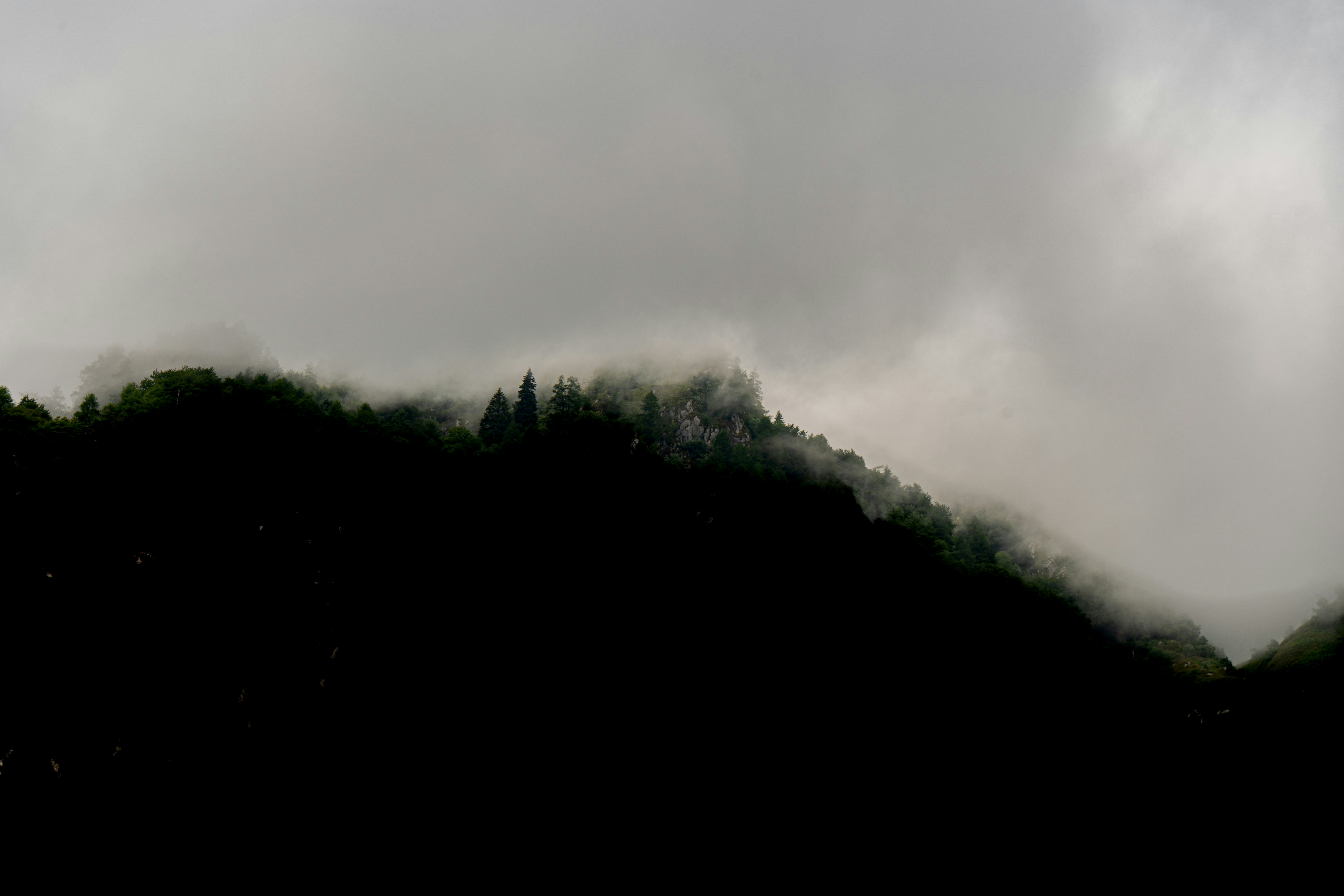 Dark stormy clouds over a silhouetted mountain range