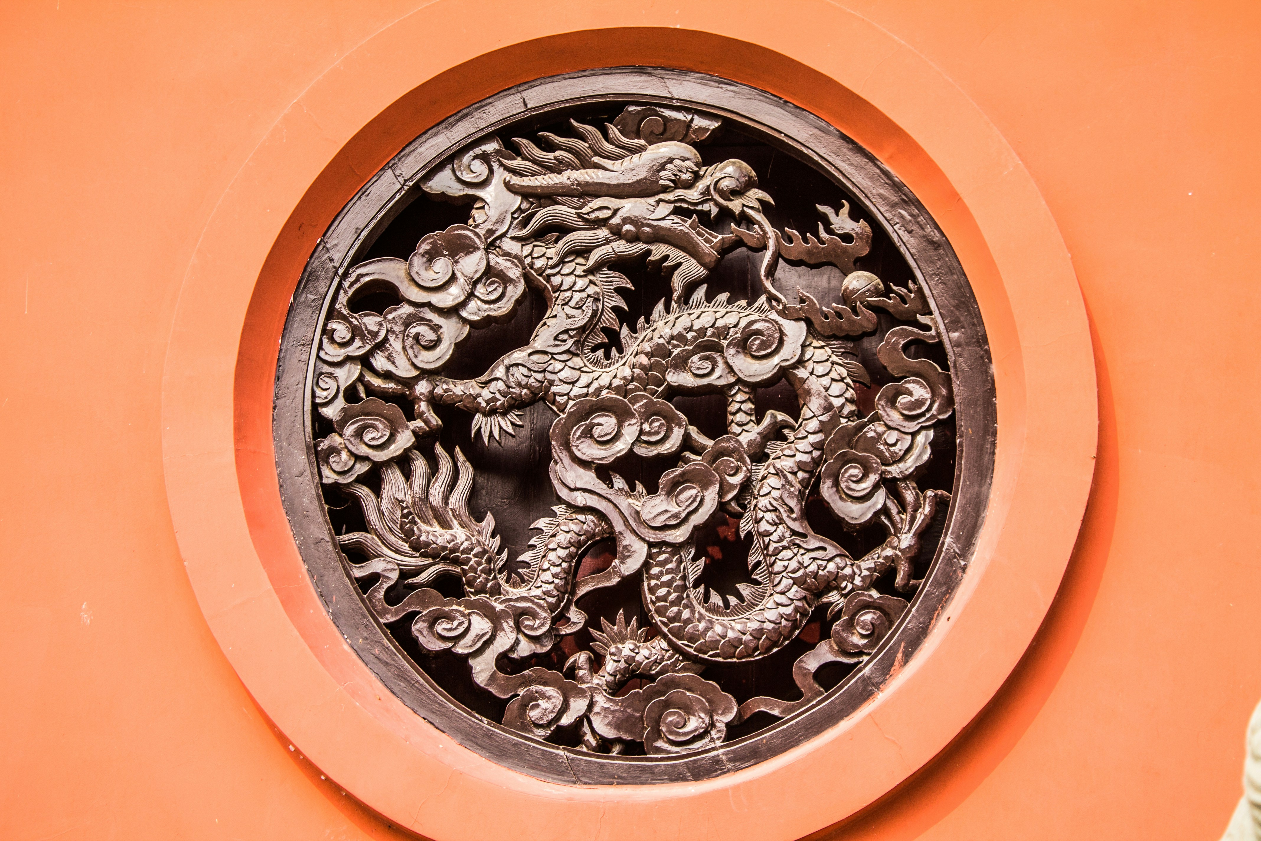 Dragon art at Lumbini | Intricate dragon carving within a circular frame